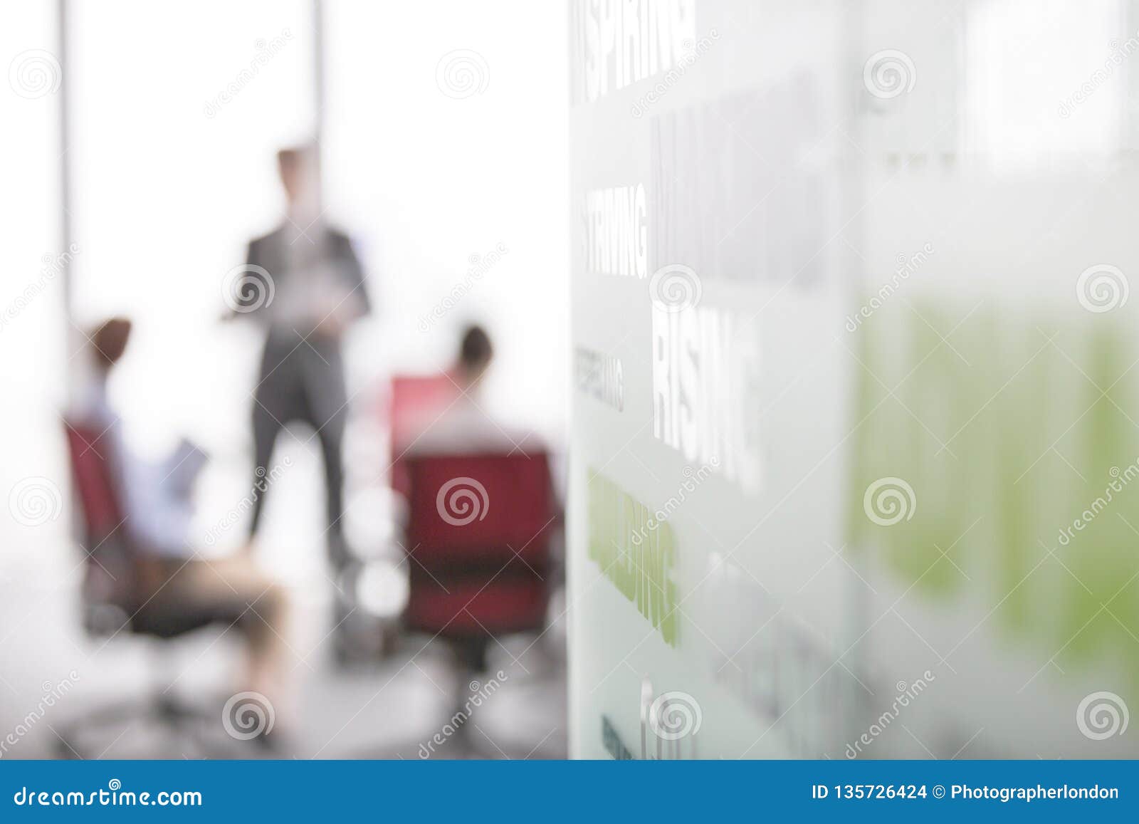 Text on Wall Against Business Colleagues Working in Boardroom at Office ...