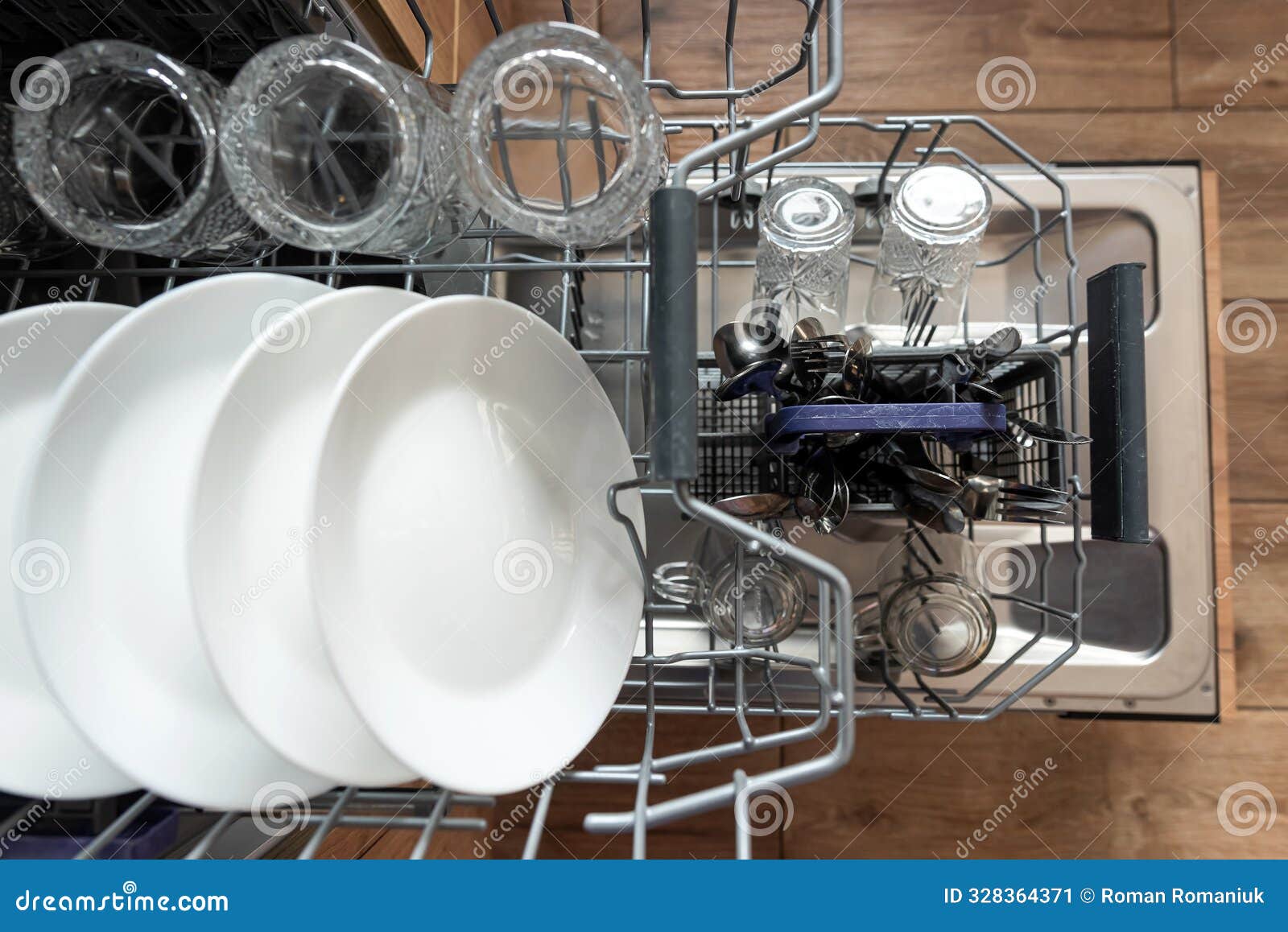 Modern Open Dishwasher with Clean Dishes after Washing Cycle at Kitchen ...