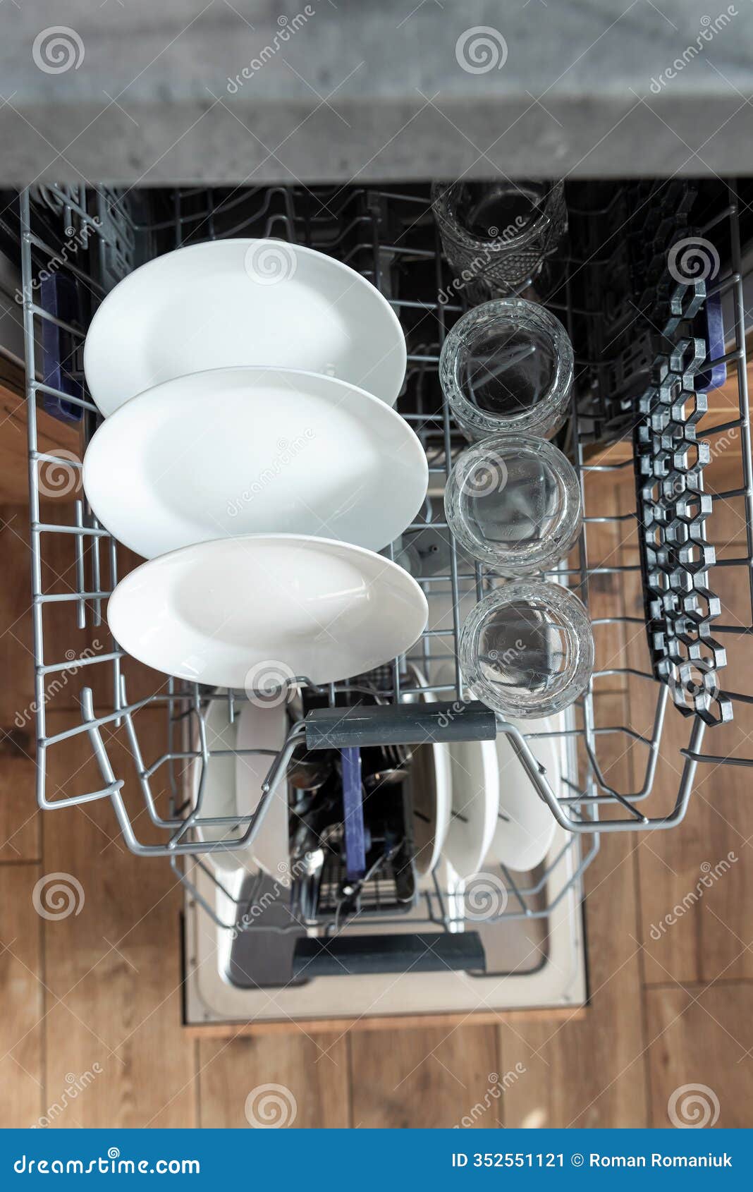 Modern Open Dishwasher with Clean Dishes after Washing Cycle at Kitchen ...