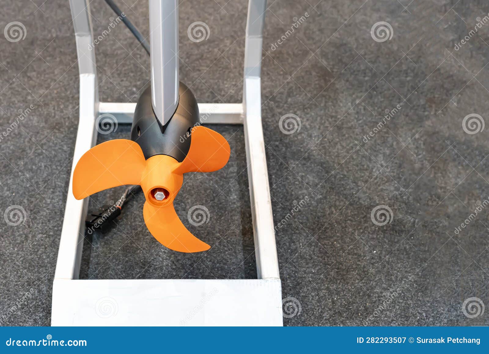 Modern Outboard Electric Motor and 3 Blade of Boat Propeller on Ground ...