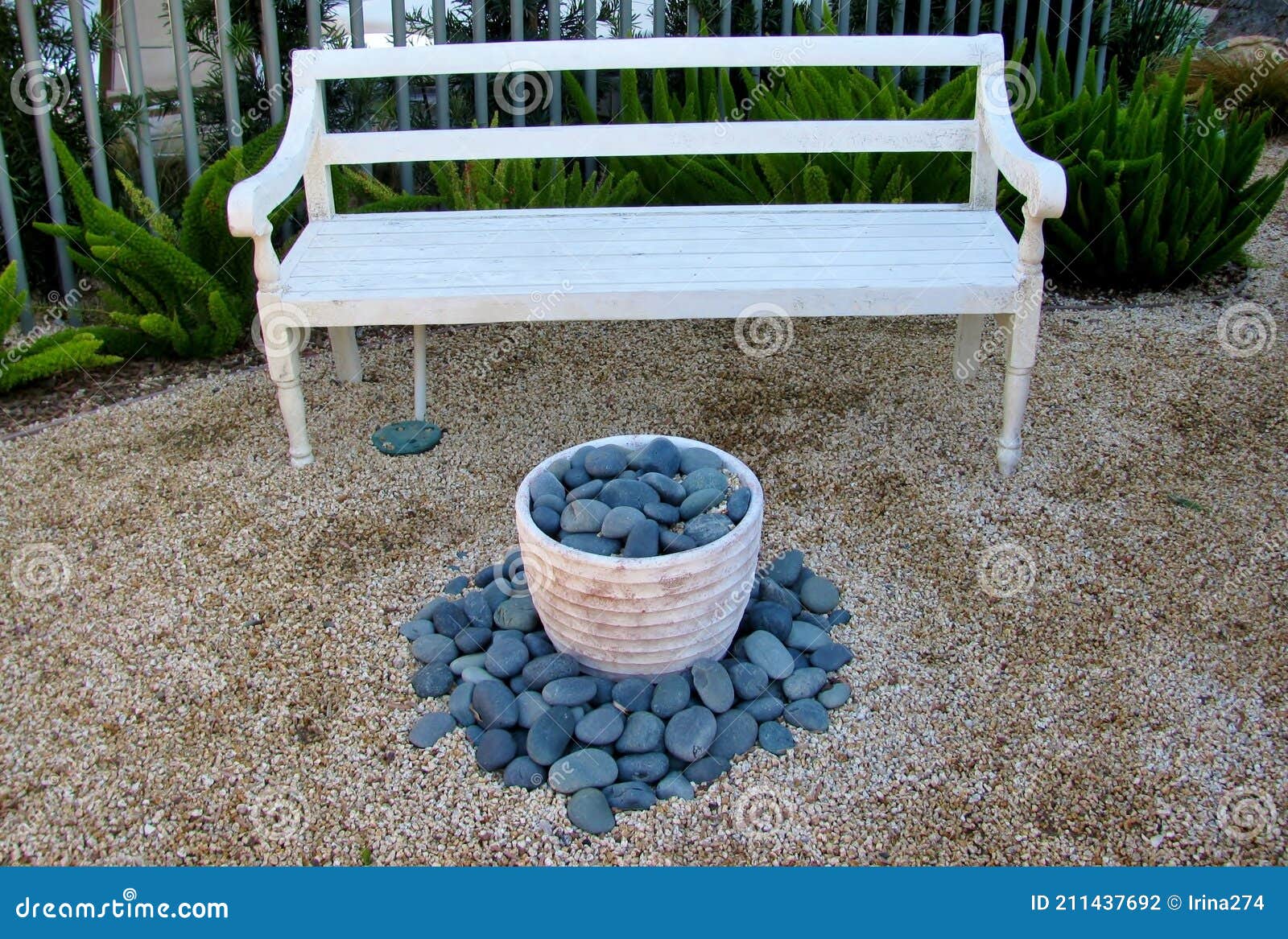 Modern Pebble Fire Pit in Front of White Bench. Stock Photo - Image of ...