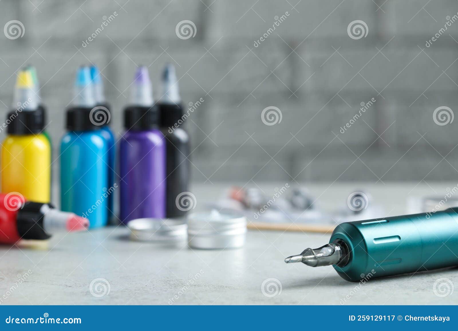 Modern Professional Tattoo Machine and Colorful Inks on White Table ...
