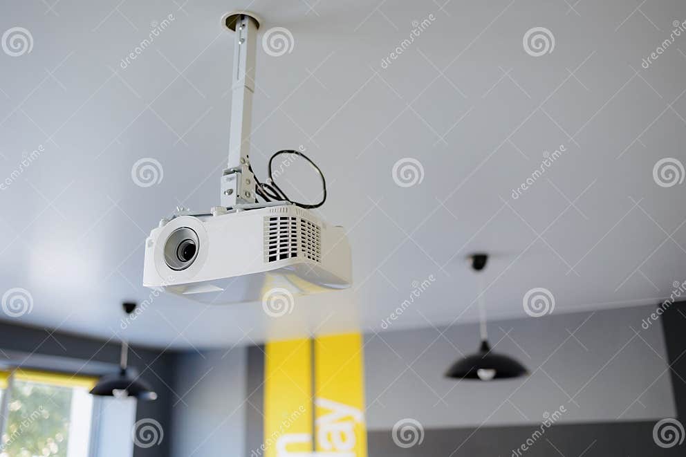 Modern Projector Hanging from Ceiling in a Creative Workspace with ...