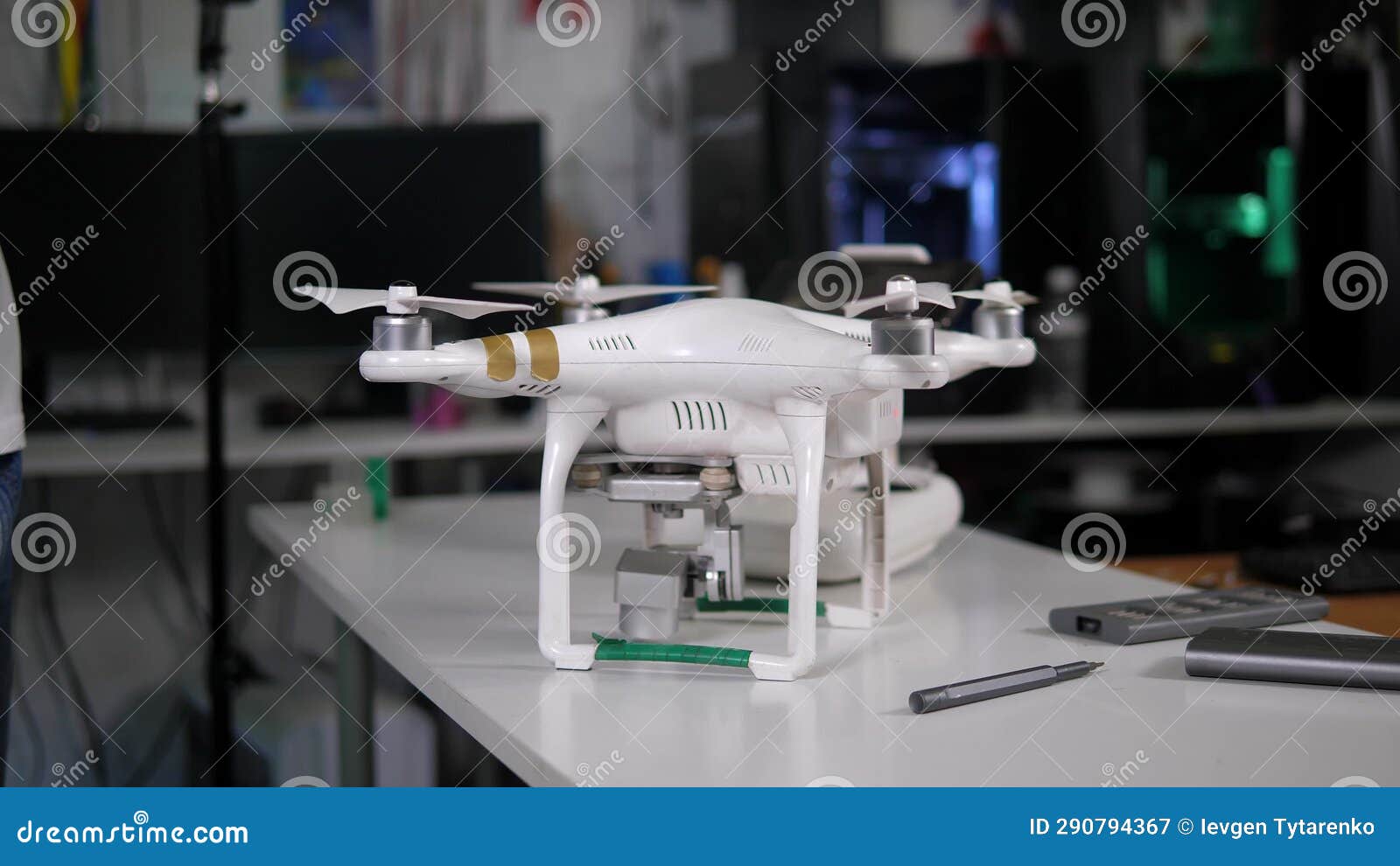 A Quadcopter with Moving Propellers and a Camera on a Table in the ...