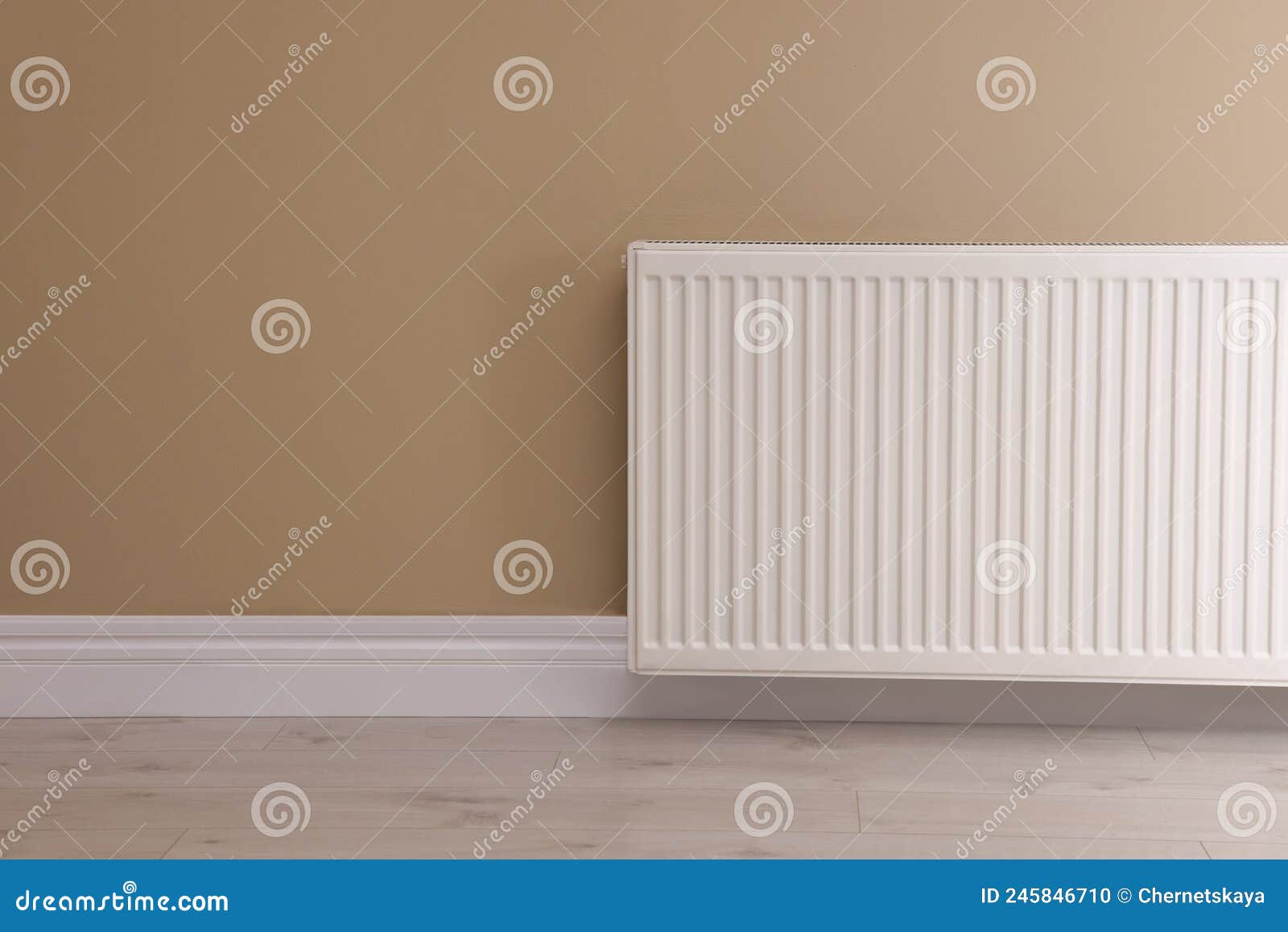 Modern Radiator on Beige Wall, Space for Text. Central Heating System ...