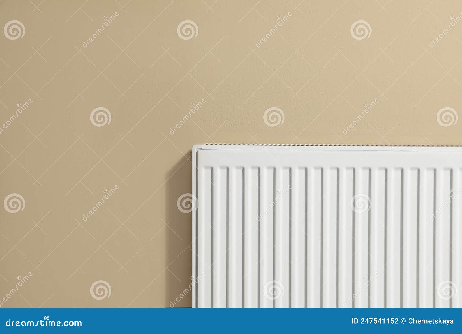 Modern Radiator on Beige Wall, Space for Text. Central Heating System ...