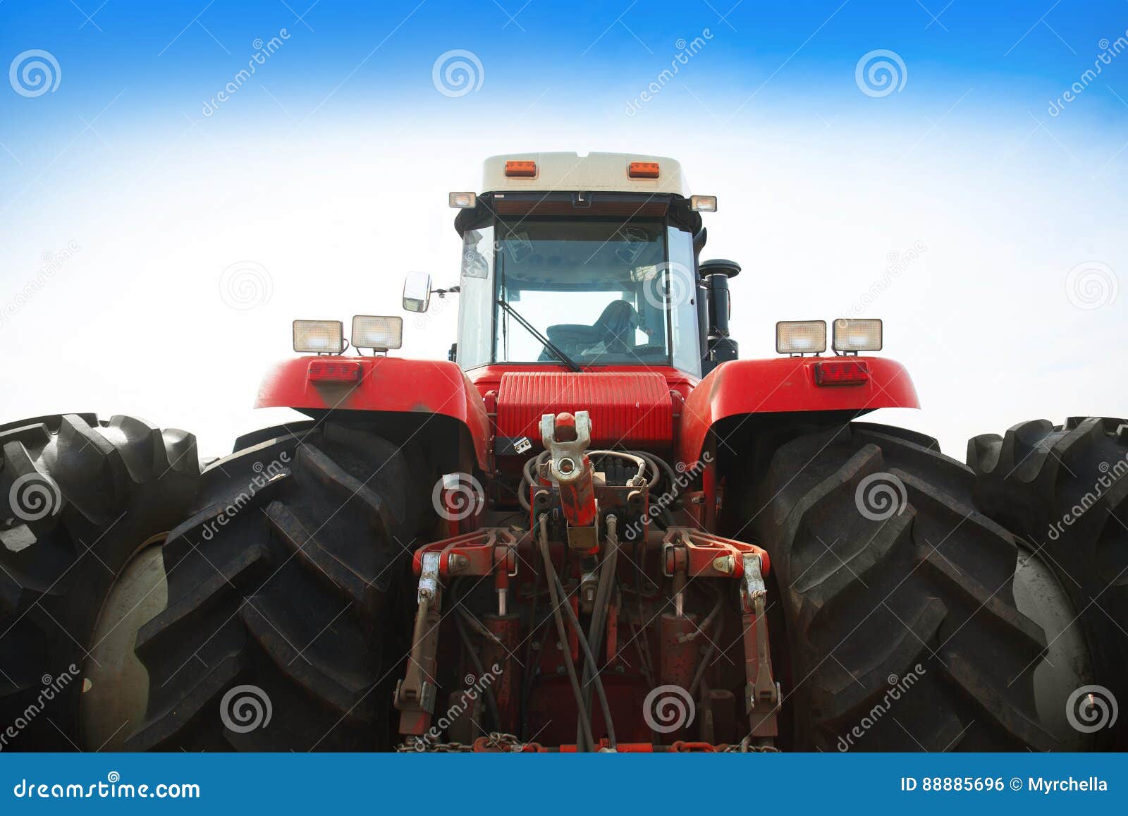 Modern Red Tractor on a Blue Sky Background. Stock Photo - Image of ...