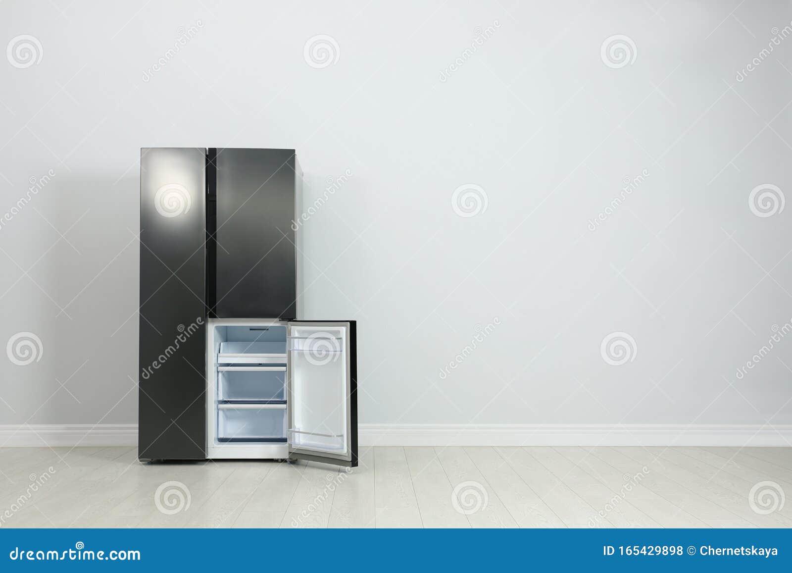Modern Refrigerator Near Light Grey Wall. Space for Text Stock Photo ...