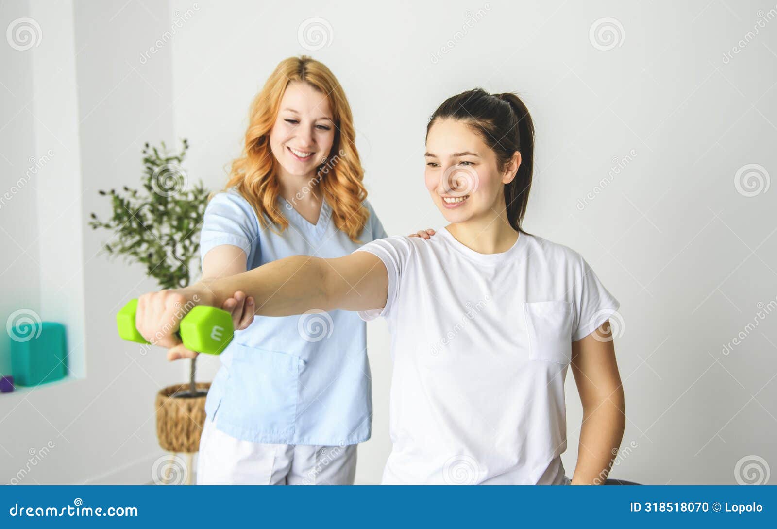 Modern Rehabilitation Physiotherapy at Work with Client Holding Dumbbell Stock Photo - Image of ...