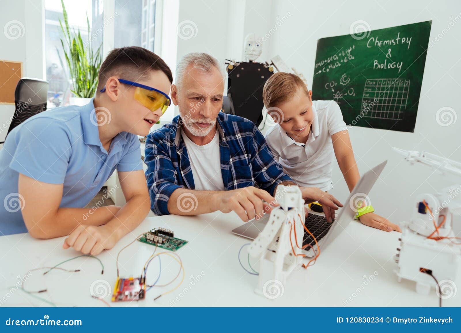 Smart Science Teacher Pointing at the Robot Stock Photo - Image of ...