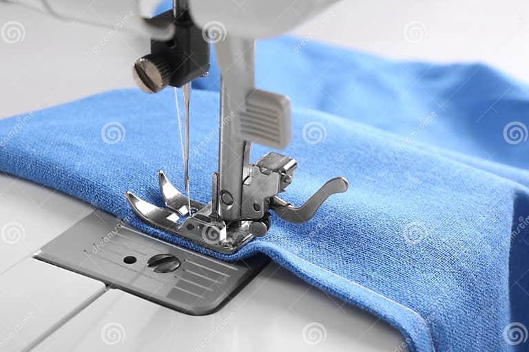 Modern Sewing Machine with Blue Cloth, Closeup Stock Image - Image of ...