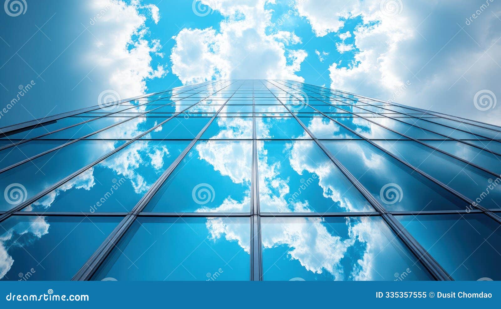 A Modern Skyscraper with Glass Facade Reflecting Sky and Clouds. Image ...