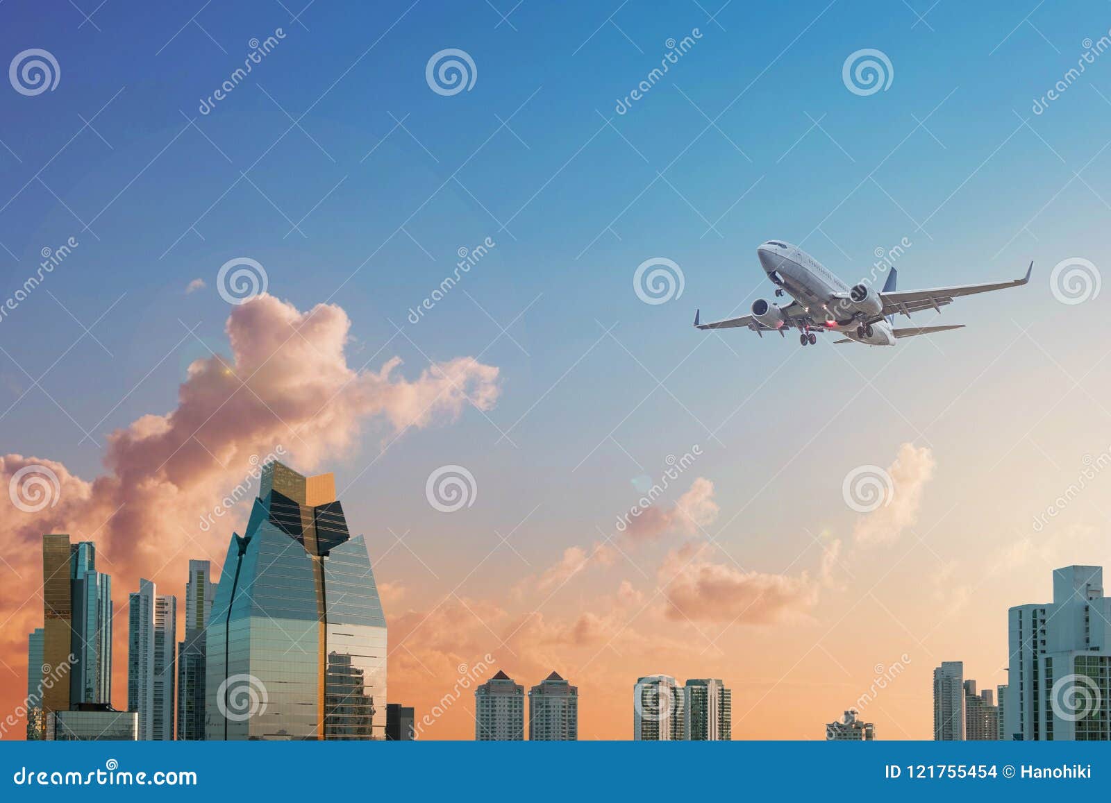 Modern Skyscraper Buildings, Skyline with Sunset Sky and Airplane Stock ...