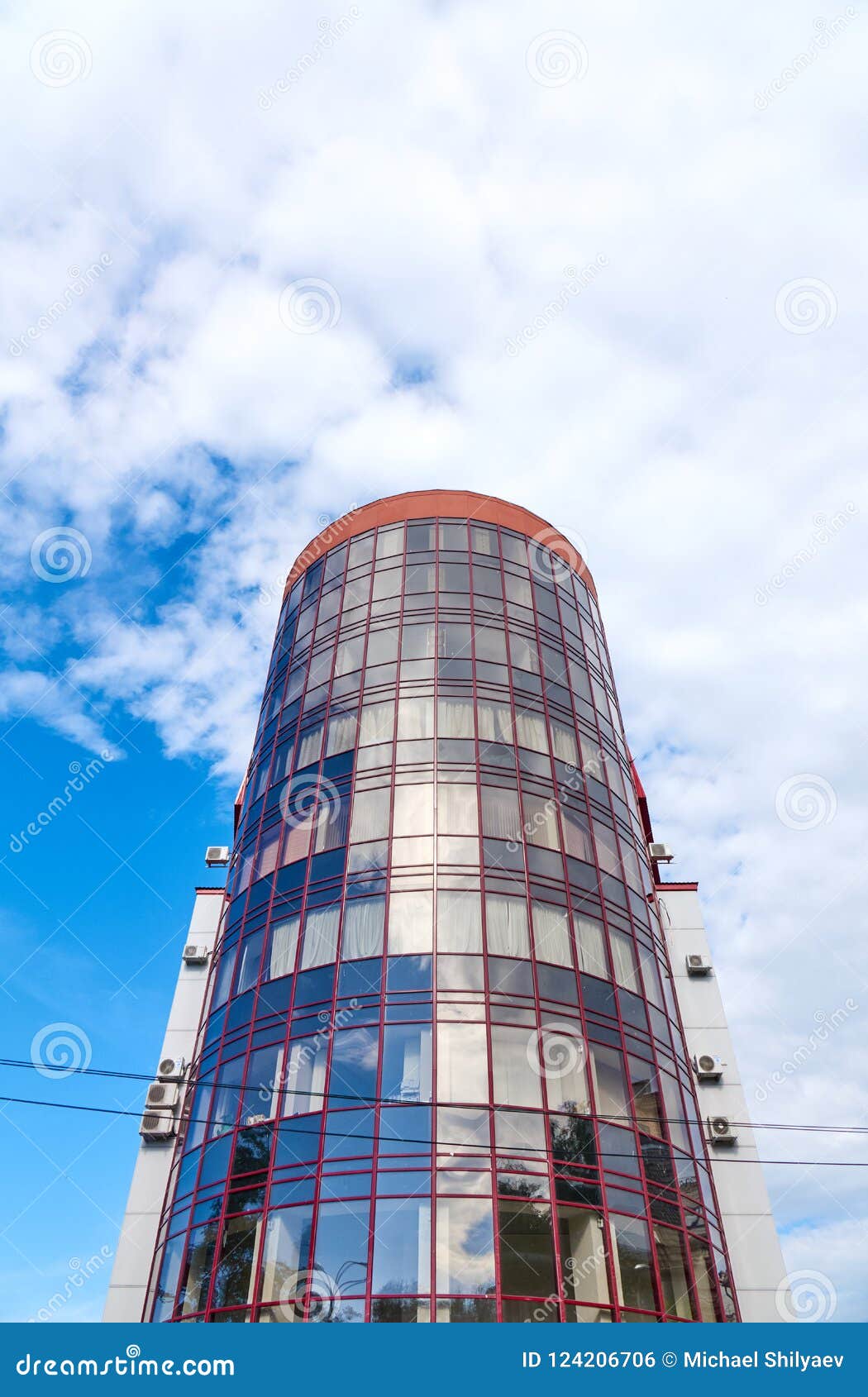 Modern Skyscraper with a Unique Round Shape, Cloudy Sky Background ...