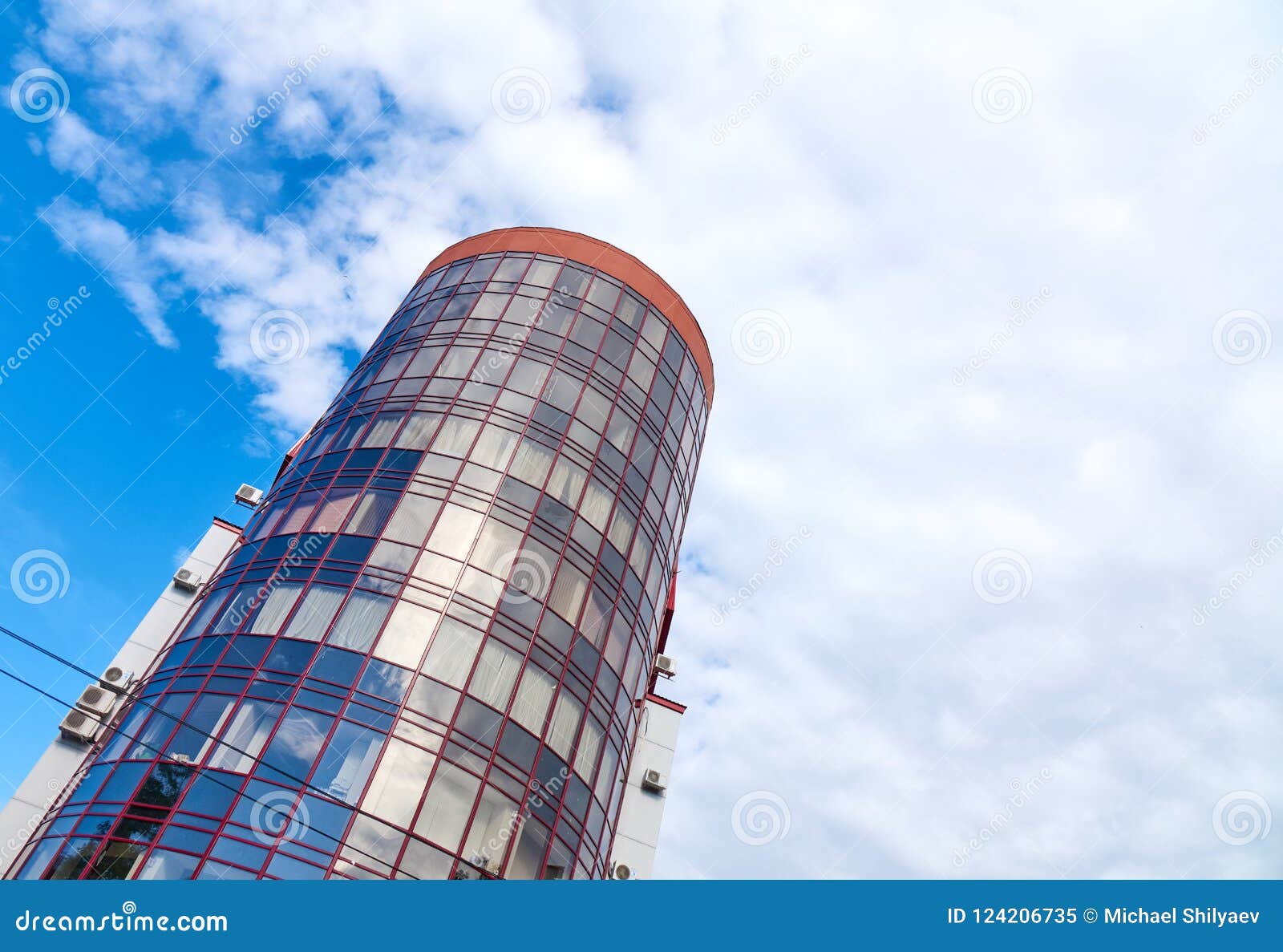 Modern Skyscraper with a Unique Round Shape, Cloudy Sky Background ...
