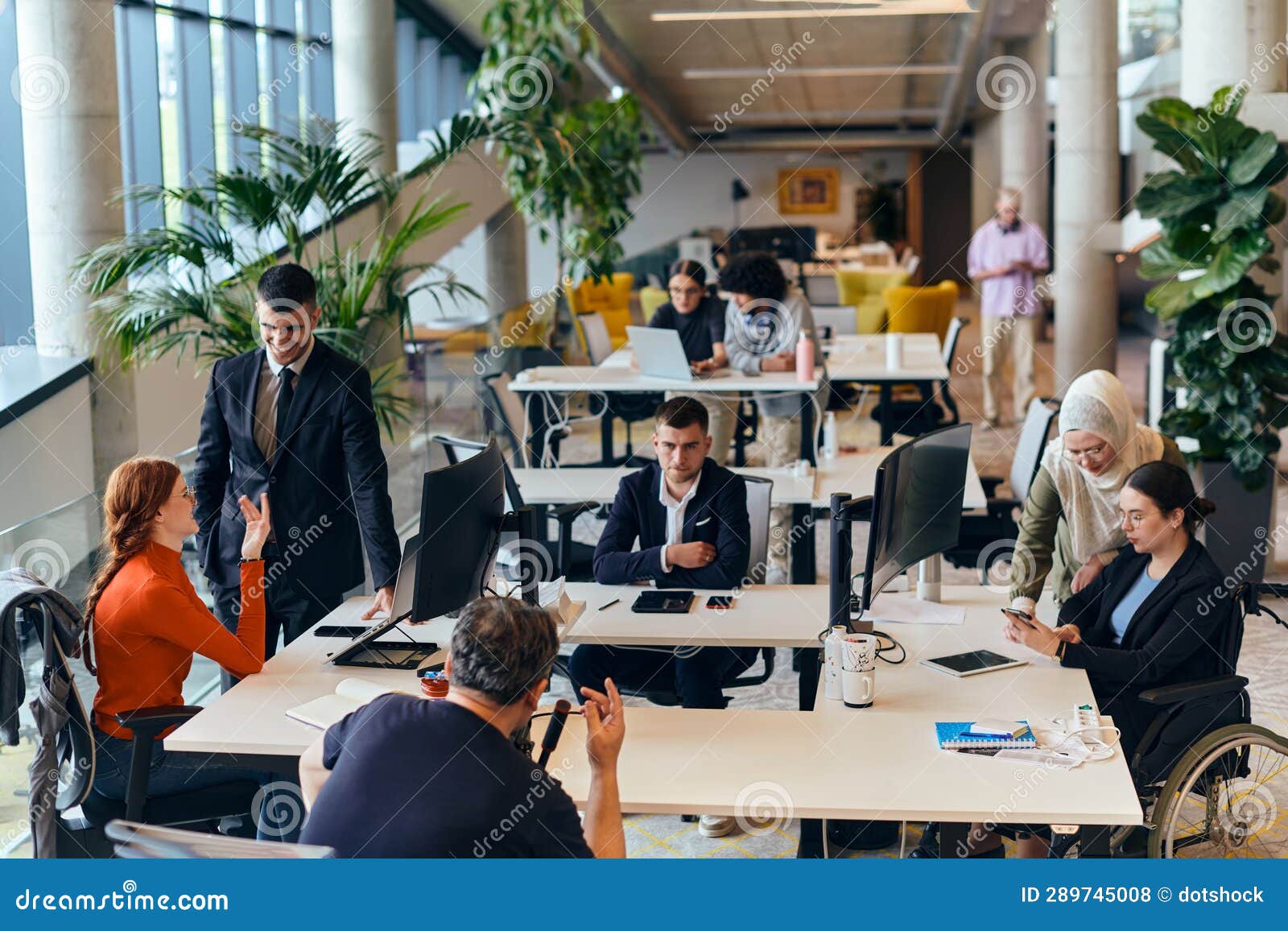 In a Modern Startup Office, a Diverse Group of Young Professionals ...