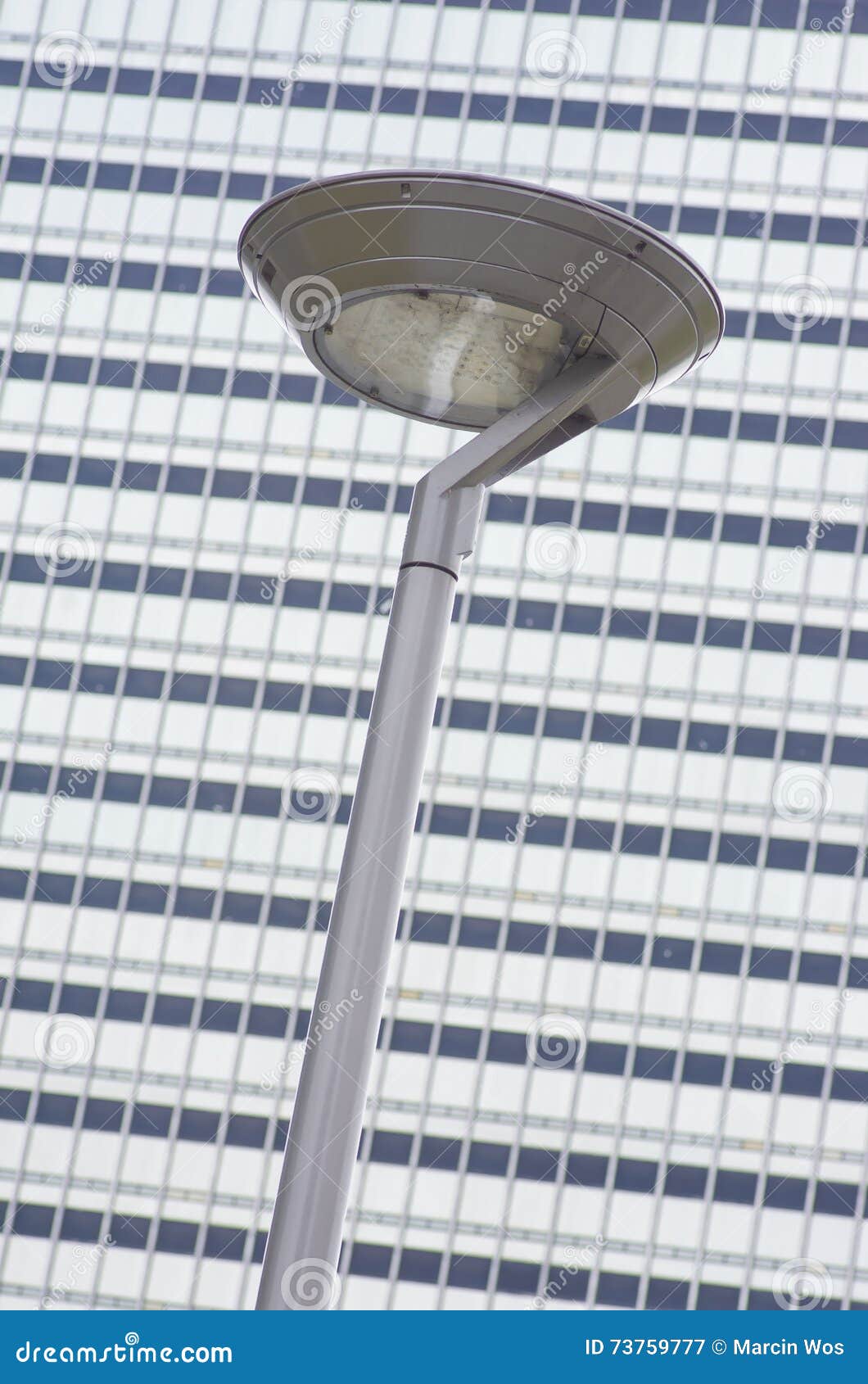 A Modern Street Lamp Post Against a Grey Building. Stock Image - Image ...