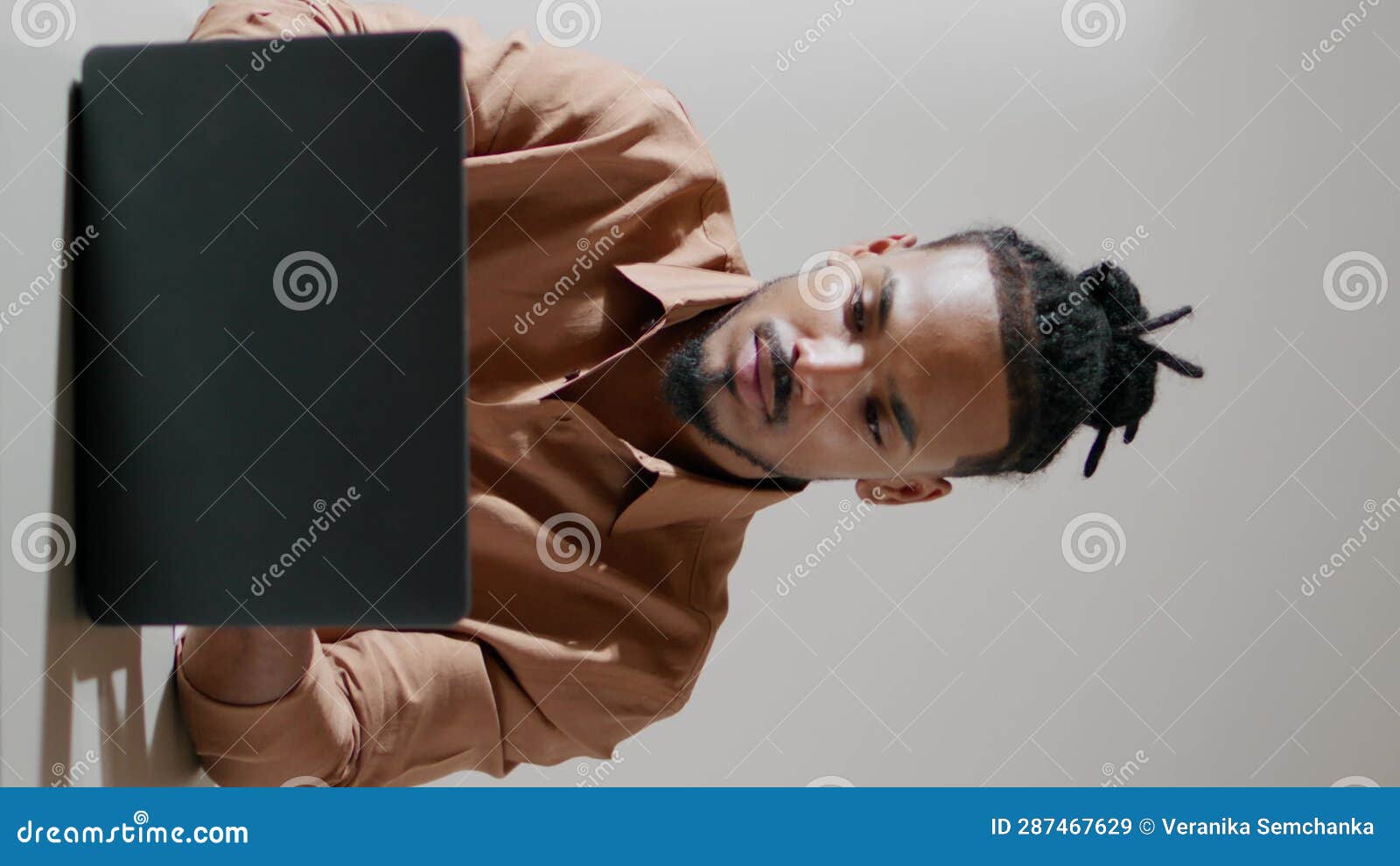 Modern Student Typing Keyboard at Workplace Vertical. Focused Man Watch ...