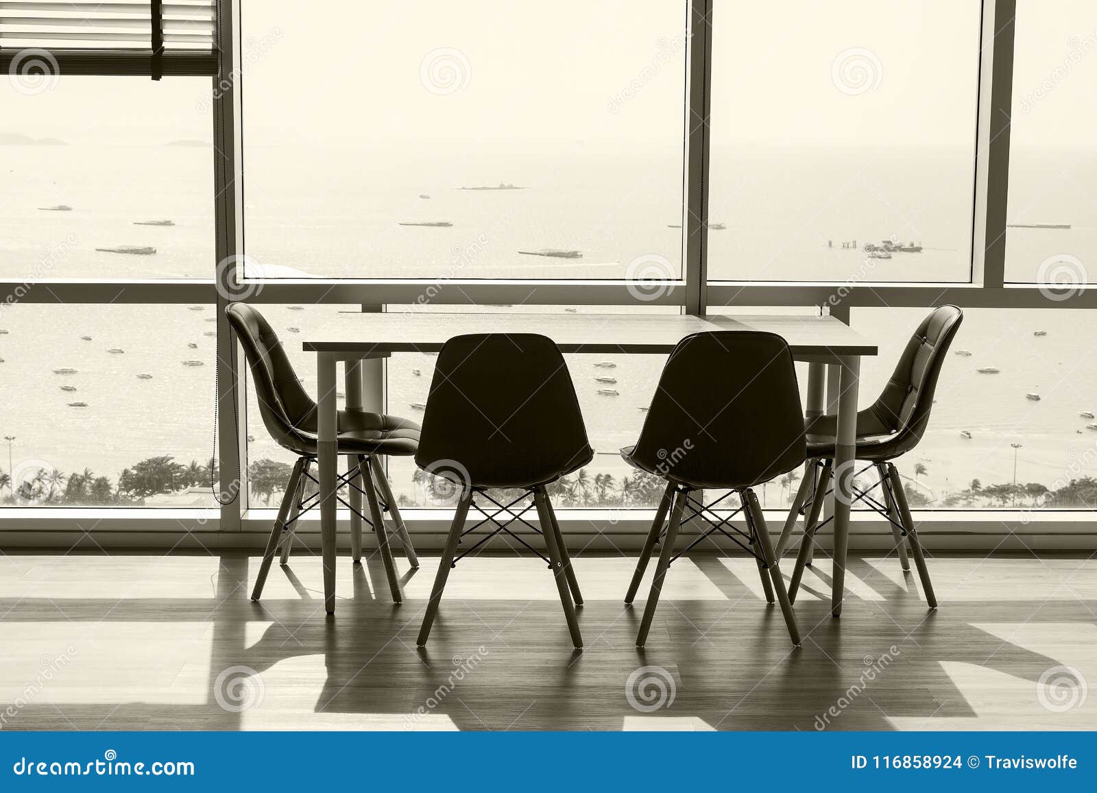 Modern Studio with Empty Desk and Glass Facade with Ocean View. Nobody ...