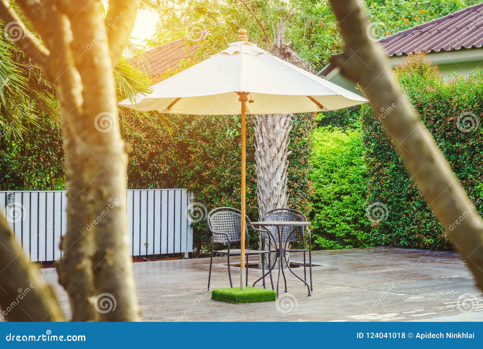 Modern Table, Chairs and Parasol on Decks Stock Photo - Image of hedge ...