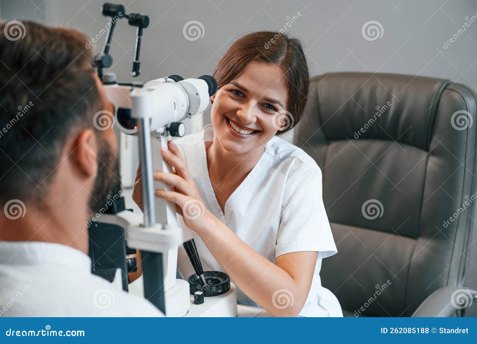 Modern Technologies. Man`s Vision Checked by Female Doctor in the ...