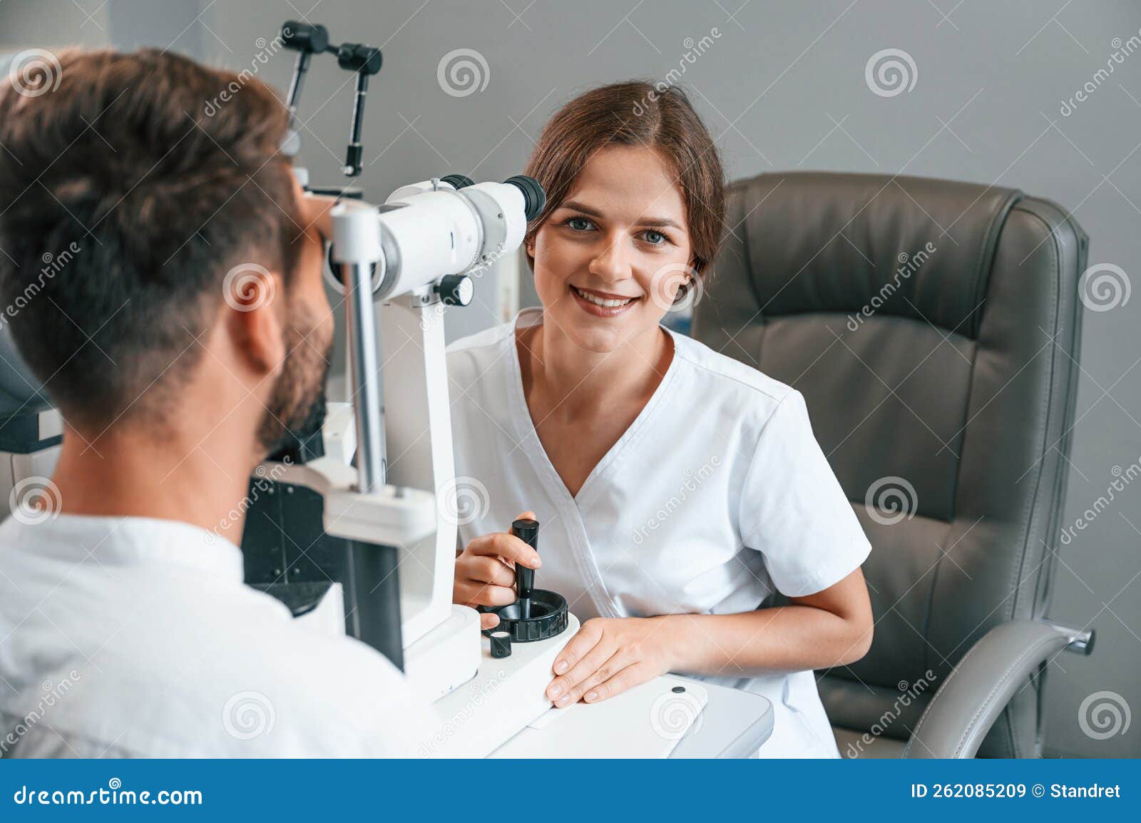 Modern Technologies. Man`s Vision Checked by Female Doctor in the ...
