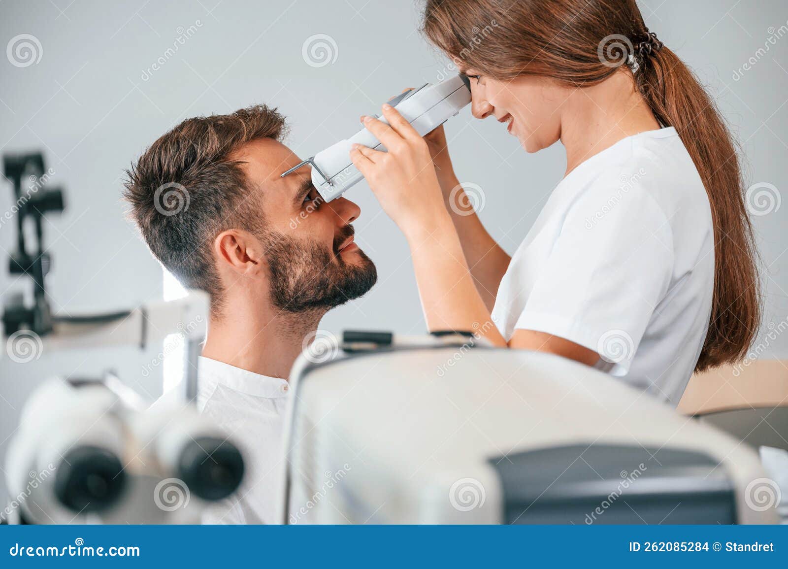 Modern Technologies. Man`s Vision Checked by Female Doctor in the ...