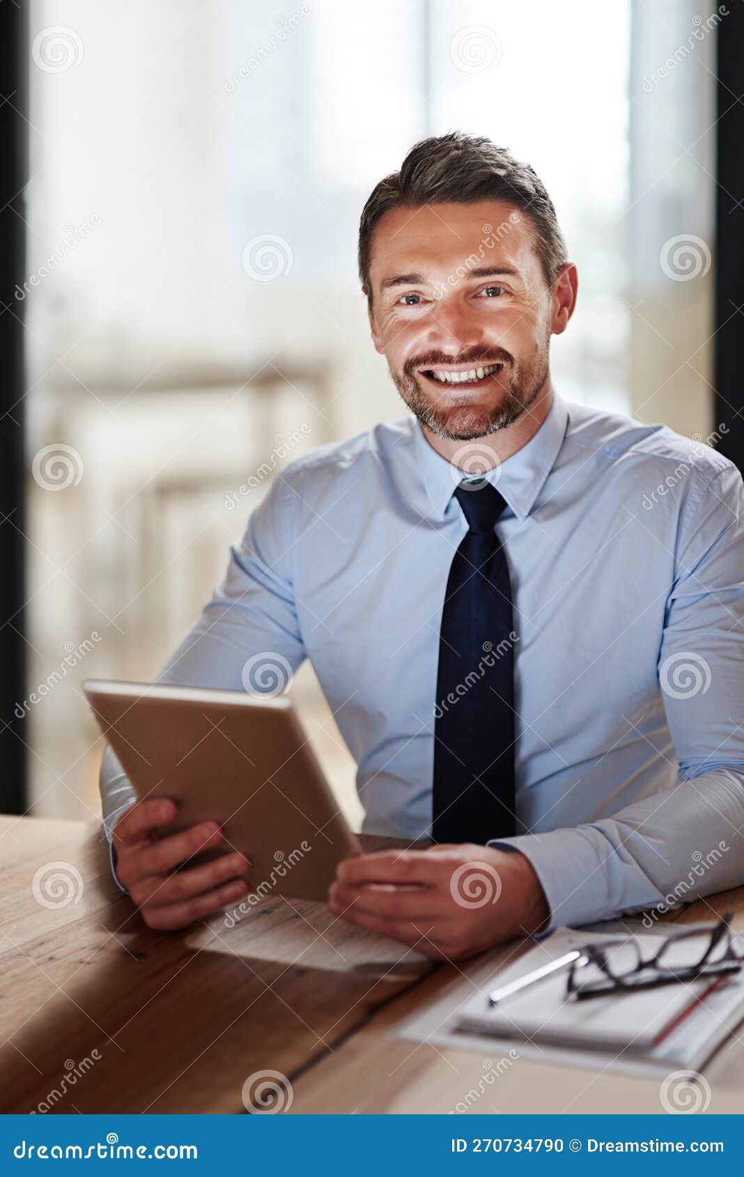 Modern Tools for a Modern Executive. Portrait of a Smiling Businessman ...