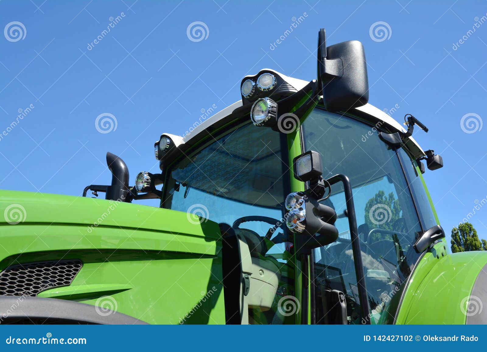 Modern Tractor Cabin. New Green Tractor with Headlights Stock Photo ...