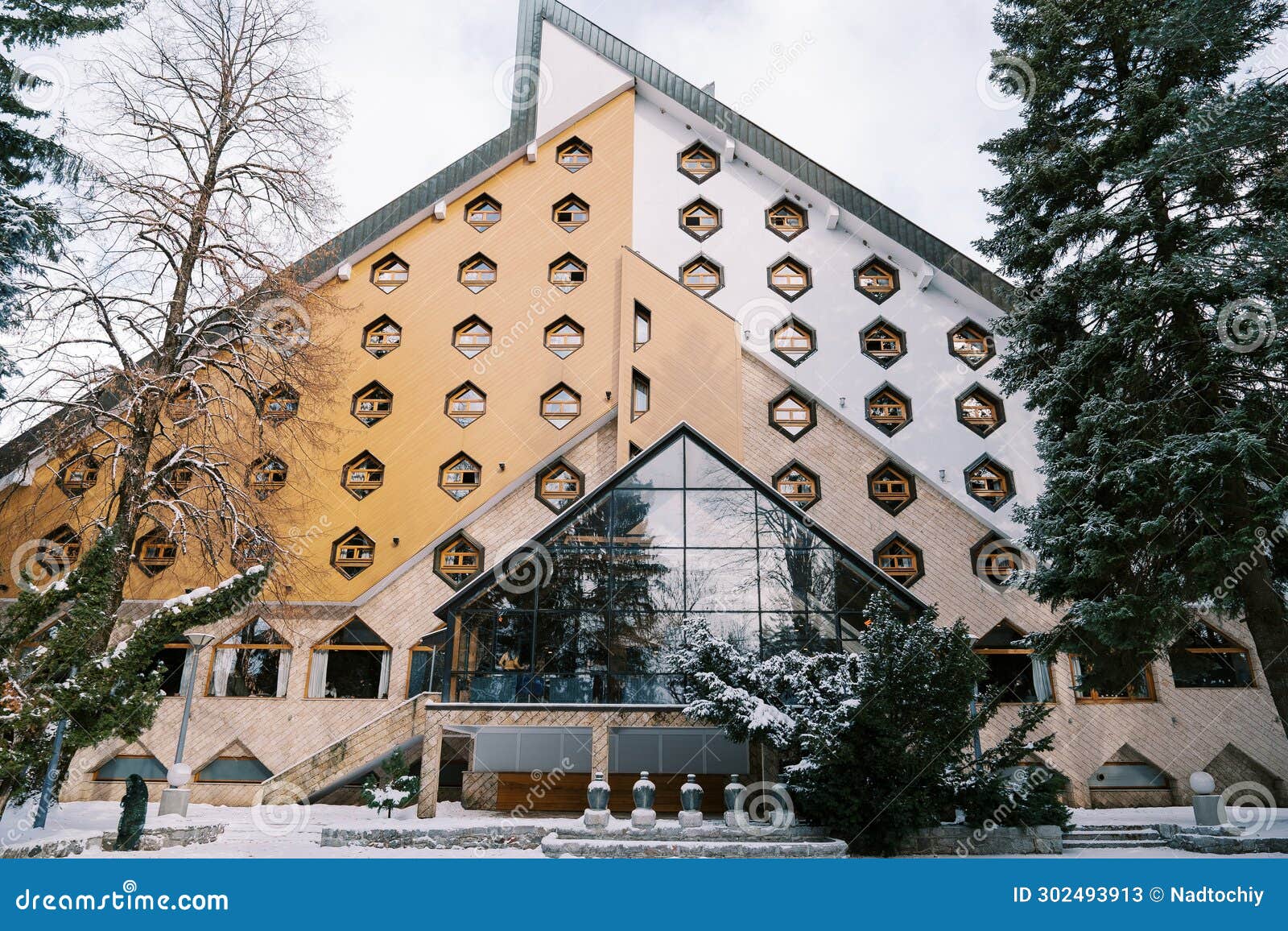 Modern Triangular Hotel Bianca with Honeycomb Windows in a Snowy Forest ...