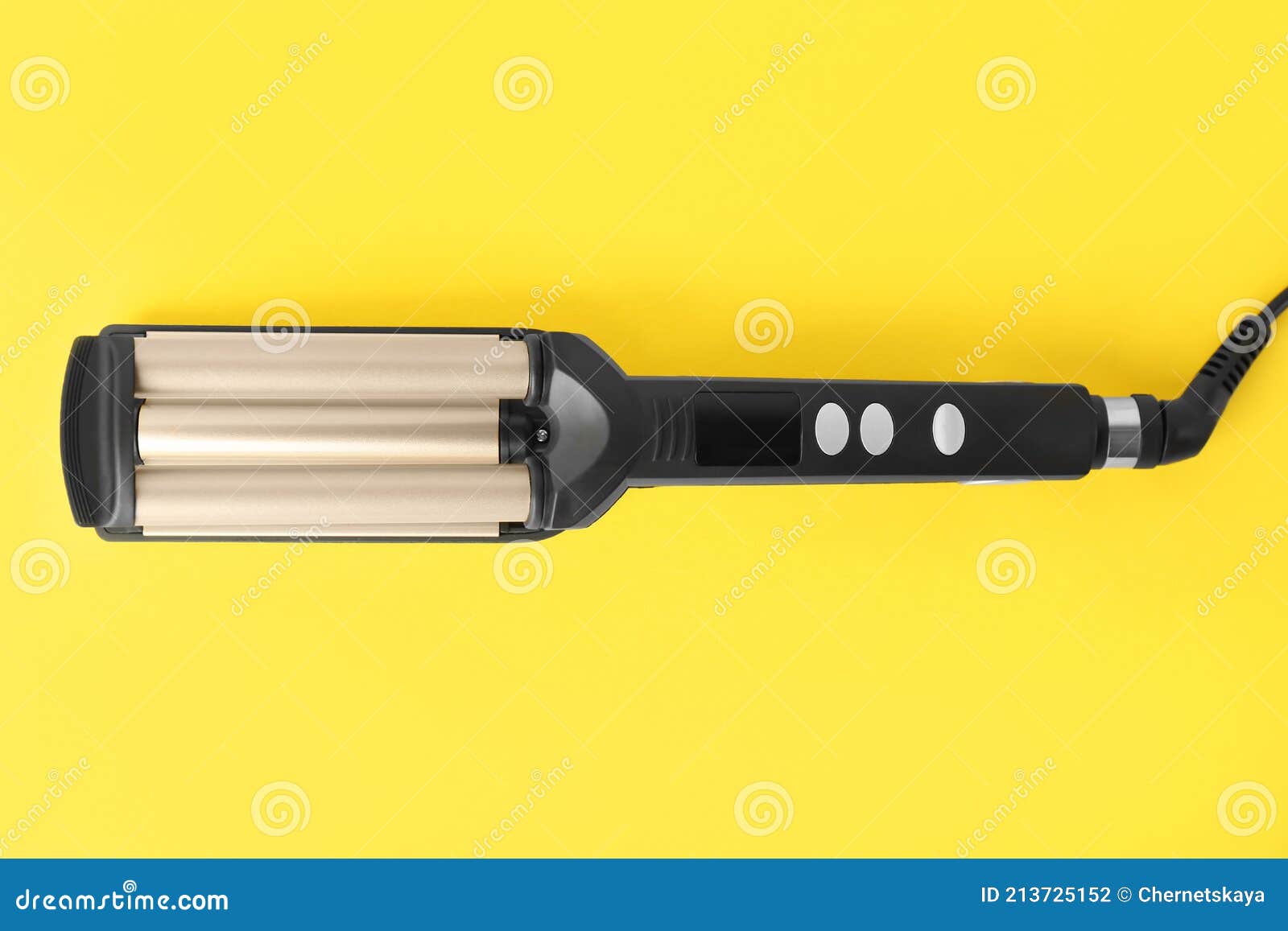 Modern Triple Curling Iron on Yellow Background, Top View Stock Photo ...