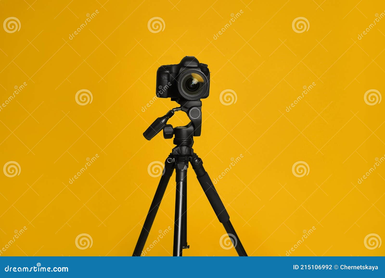 Modern Tripod with Professional Camera on Yellow Background Stock Photo ...