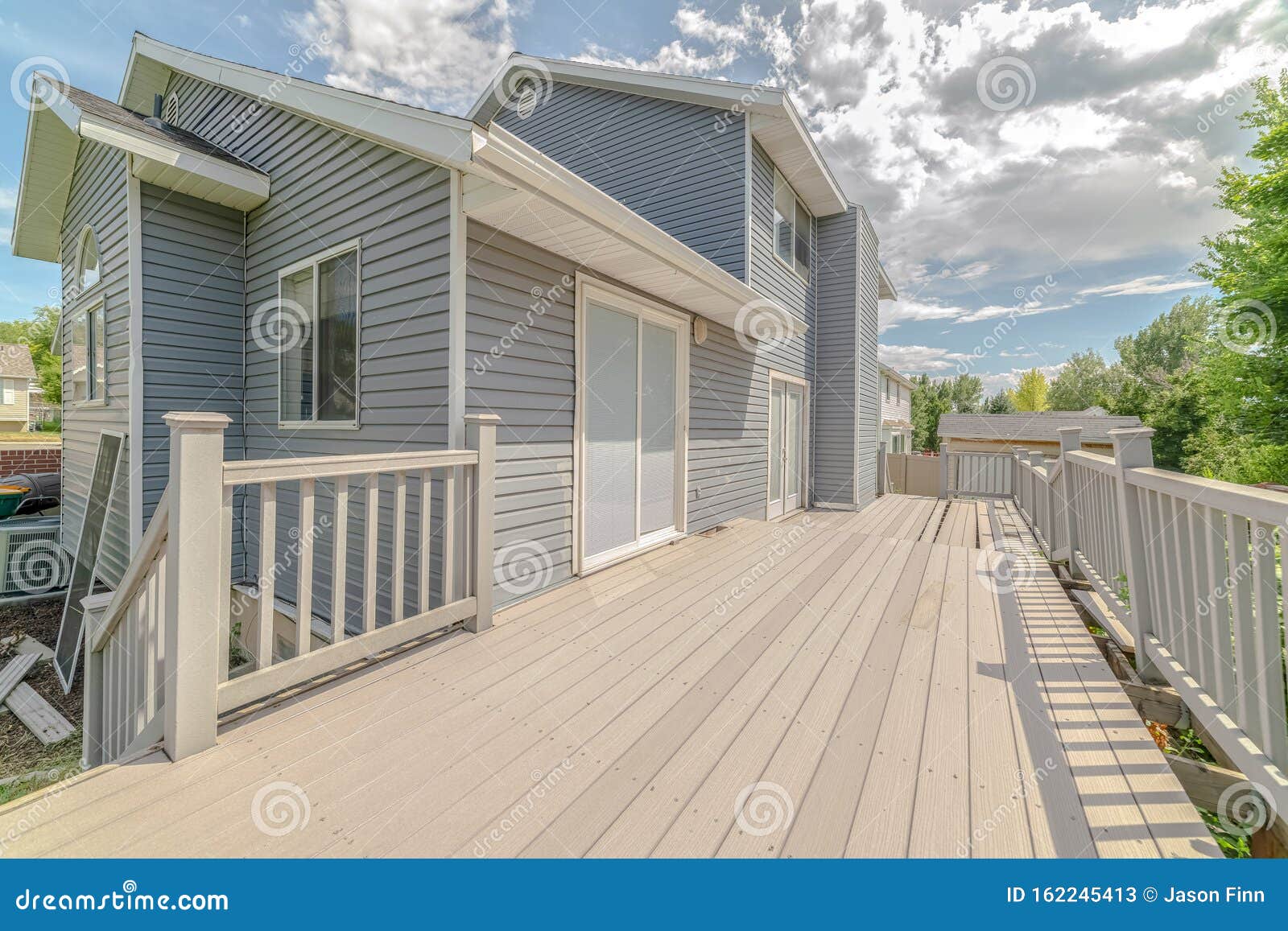 Two Storey Home Facade With Stone Brick Wall And Glass Paned Gray Front ...