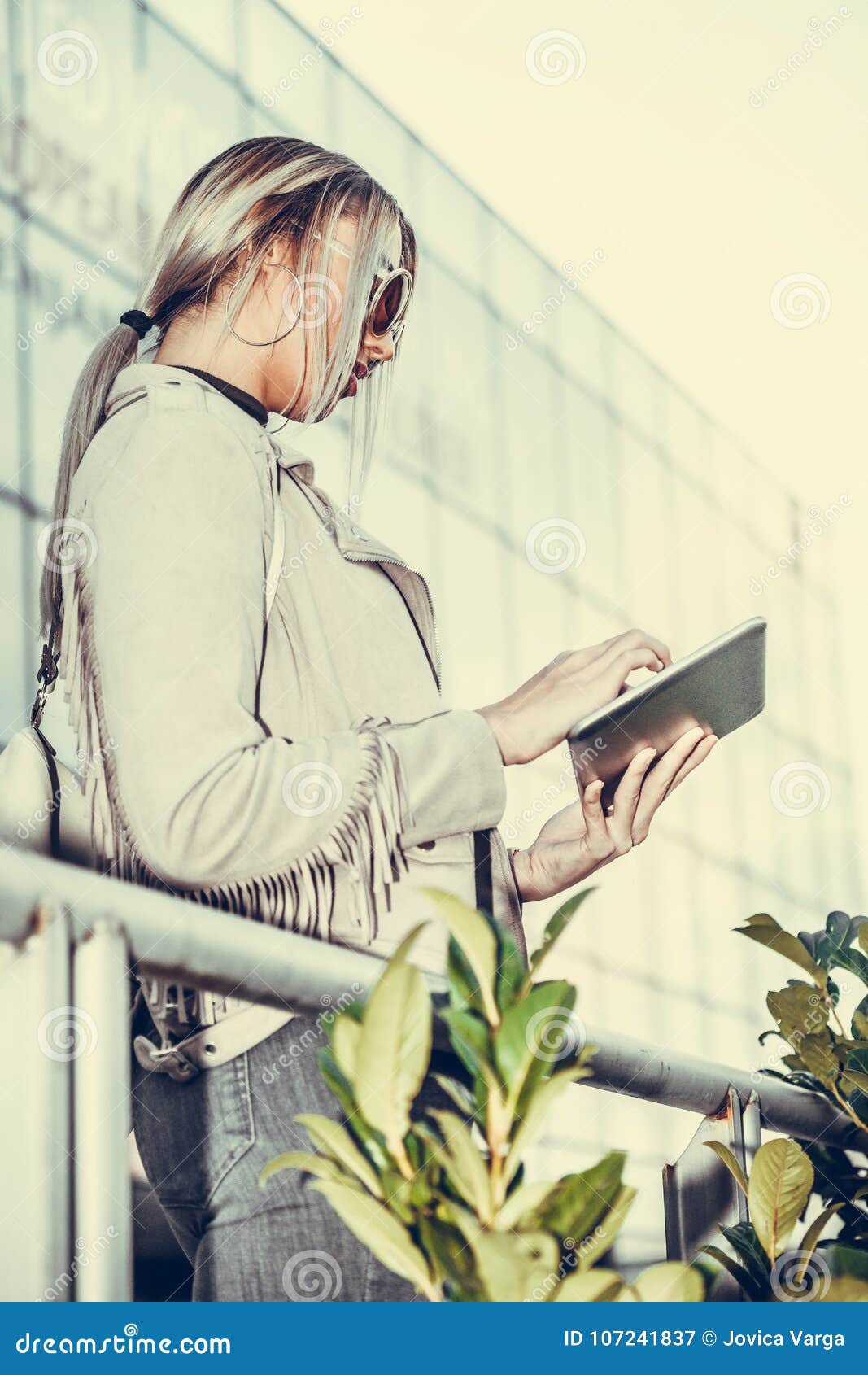 Using technology outdoors stock image. Image of lady - 107241837