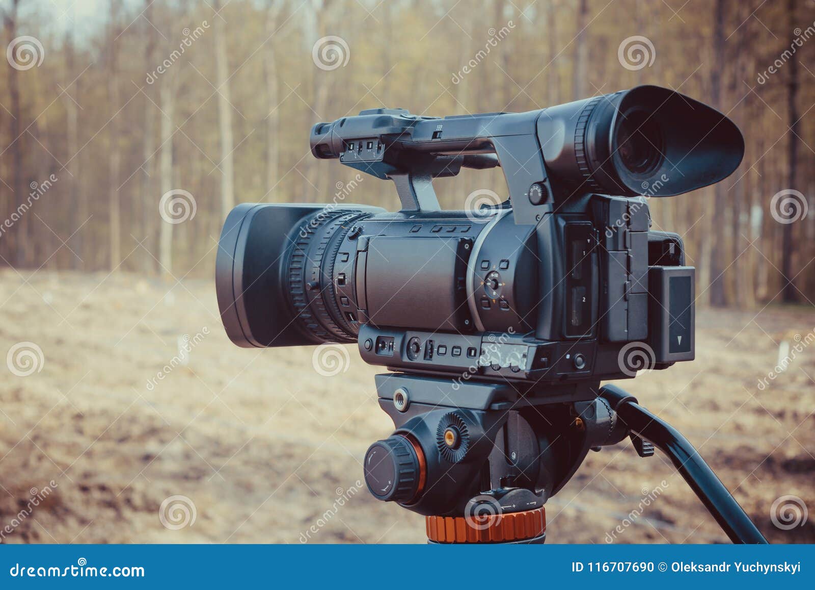 A Modern Video Camera on a Tripod Against the Forest Stock Photo ...