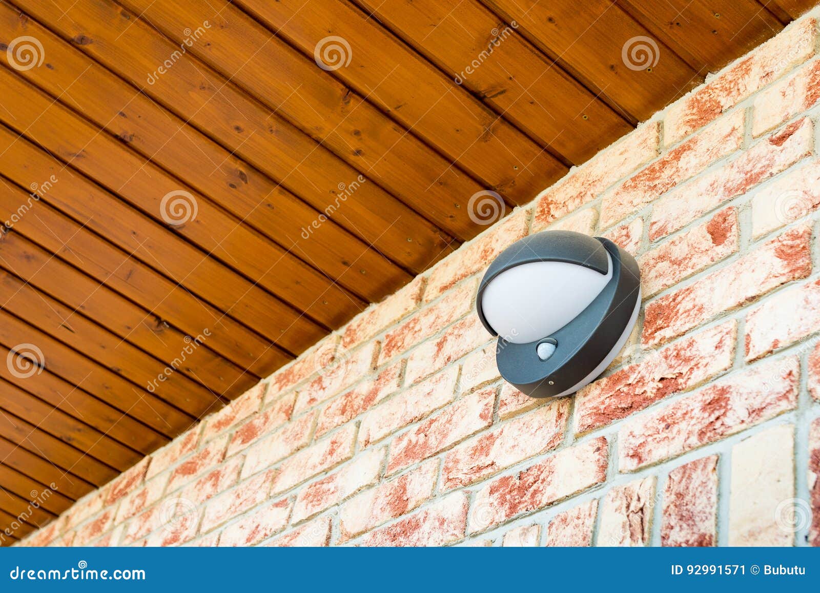 Modern Wall Lamp with Motion and Light Sensor on the Brick Wall Stock ...