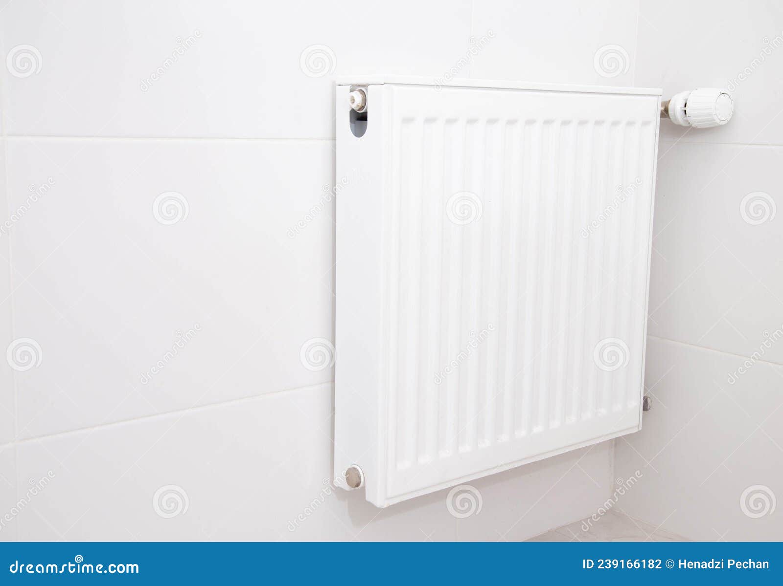 Modern Wall-mounted Heating Radiator with Thermostat on the White Wall ...