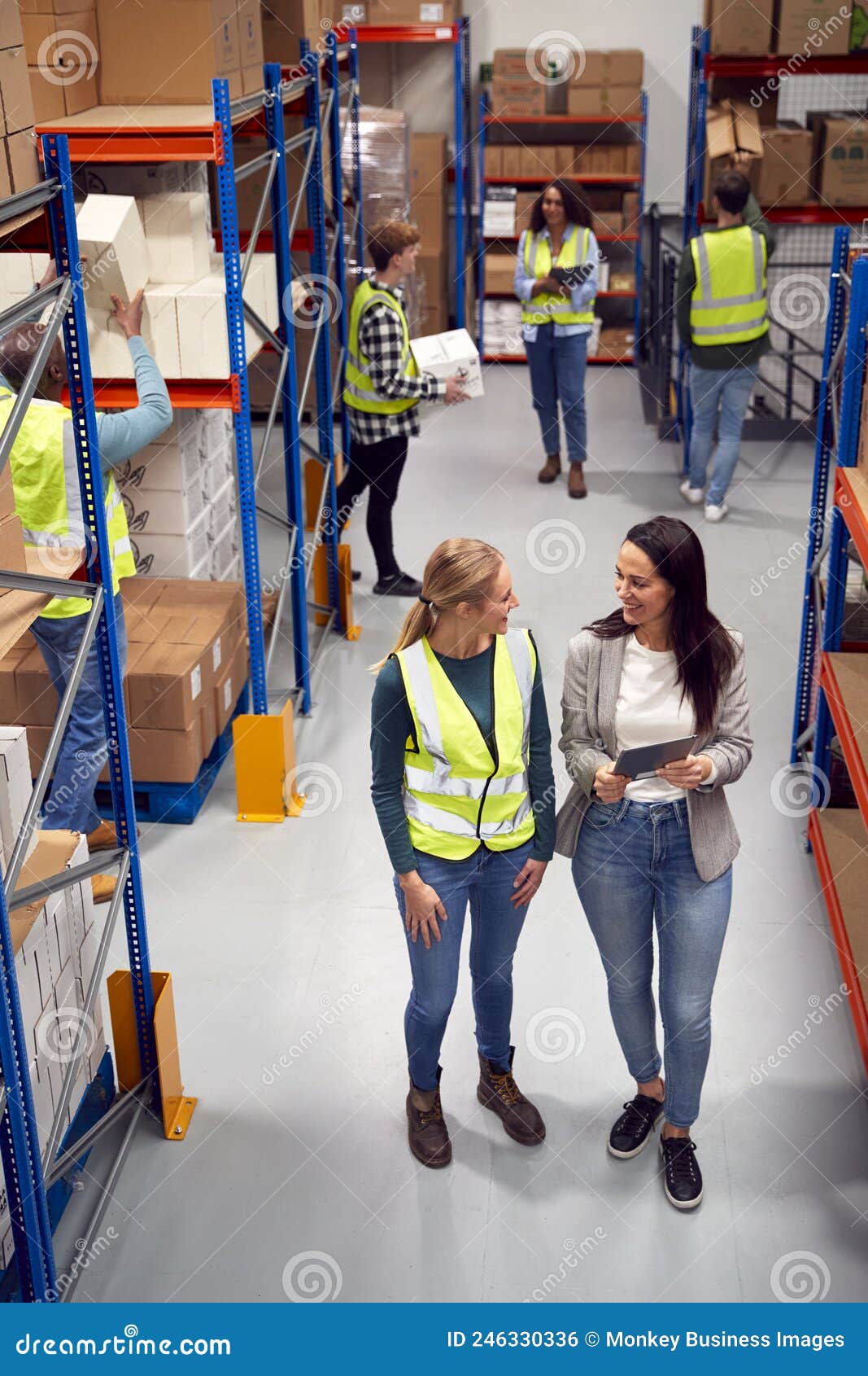 Modern Warehouse with Fulfilment Staff Picking Items from Shelves and ...