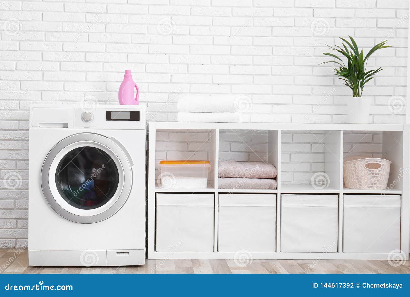 Modern Washing Machine Near Brick Wall in Laundry Room Stock ...