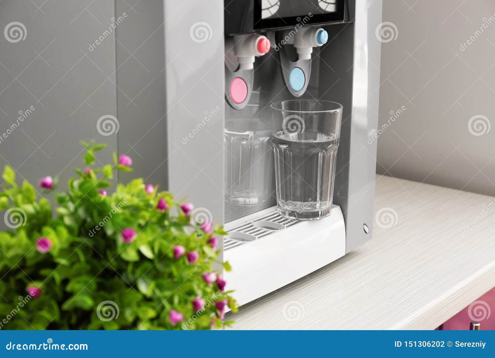 Modern Water Cooler with Glass on Kitchen Table Stock Photo - Image of ...
