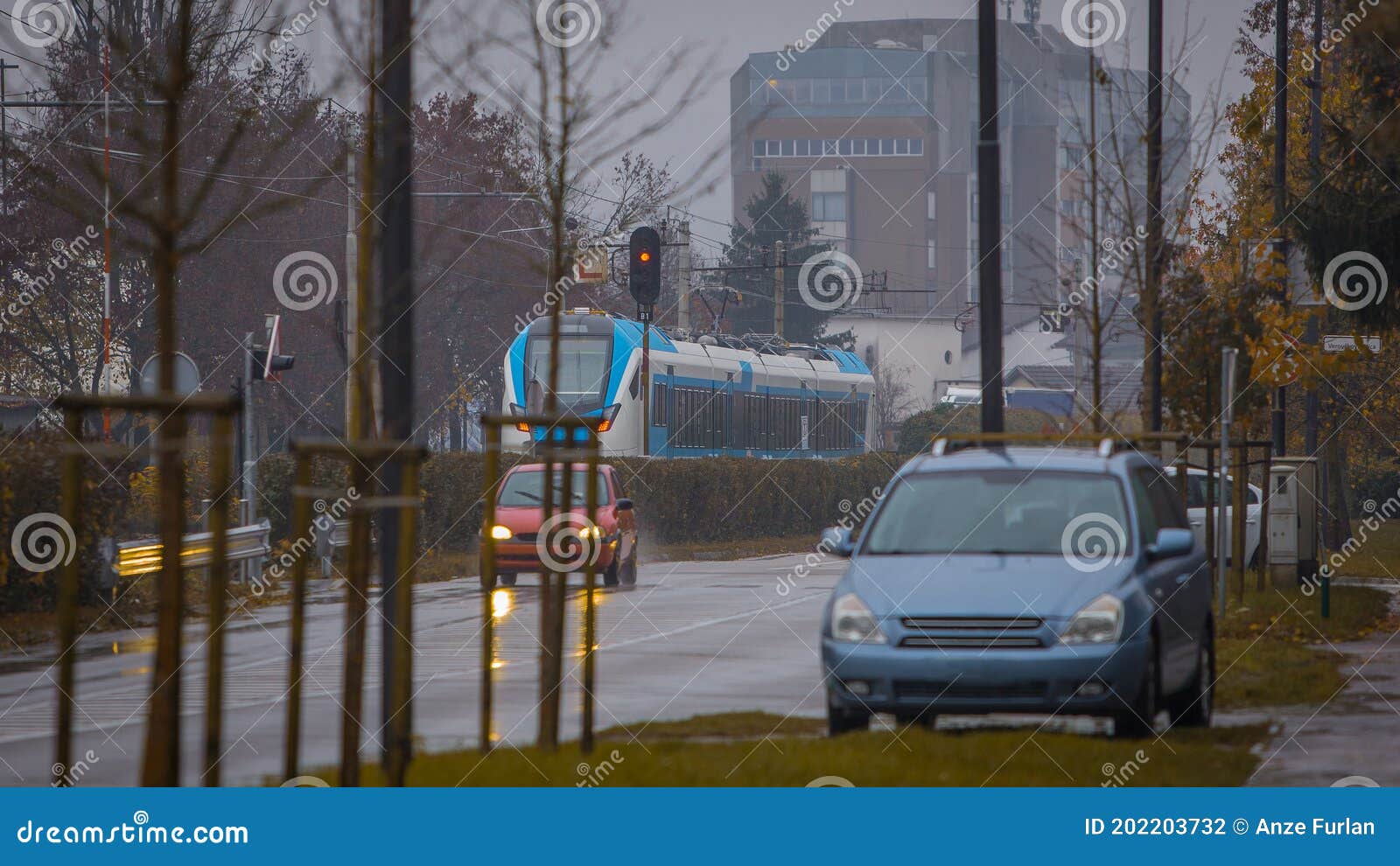 Modern White and Blue Passenger Commuter Train Passing by in Rain ...