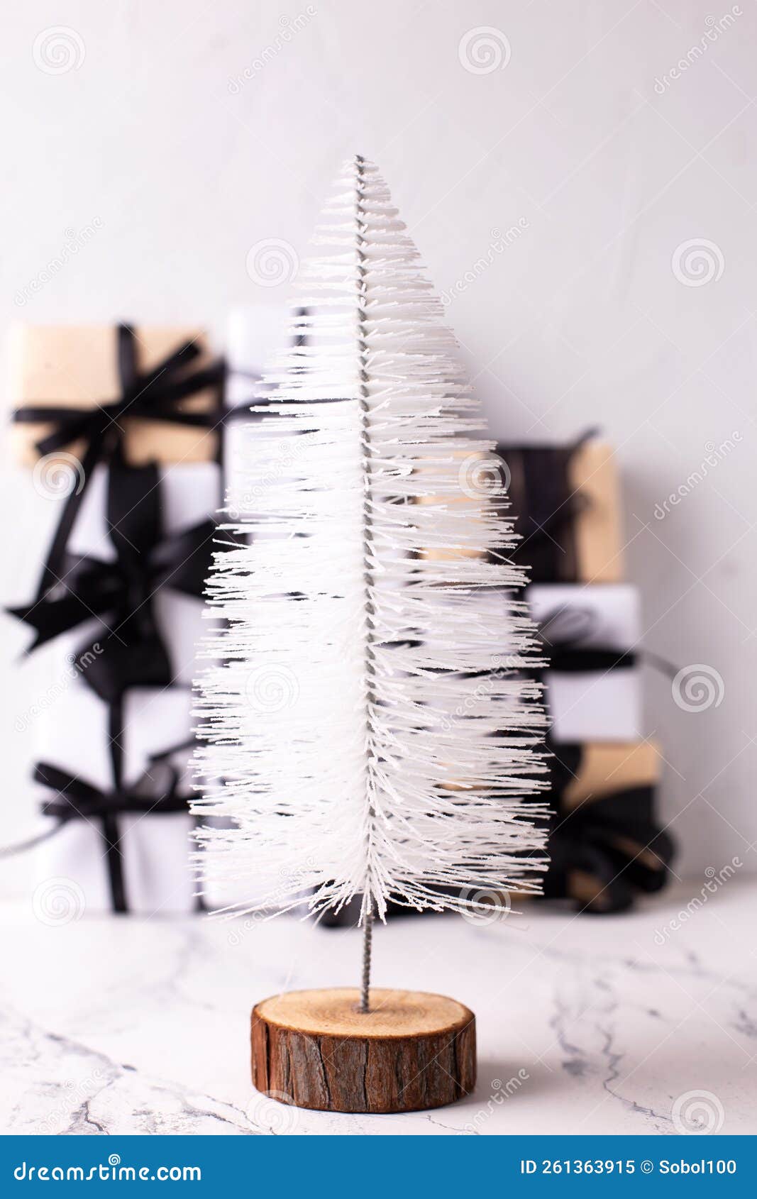 Modern White Decorative Christmas Tree in Front of Group of Wrapped ...