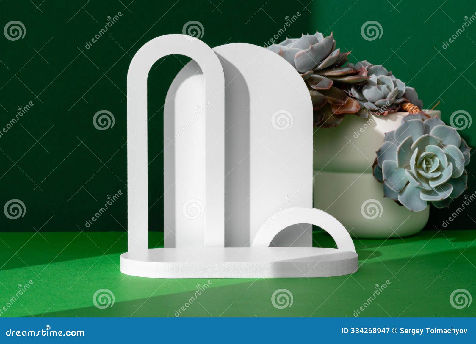 Modern White Geometric Sculpture with Succulents on a Green Table ...