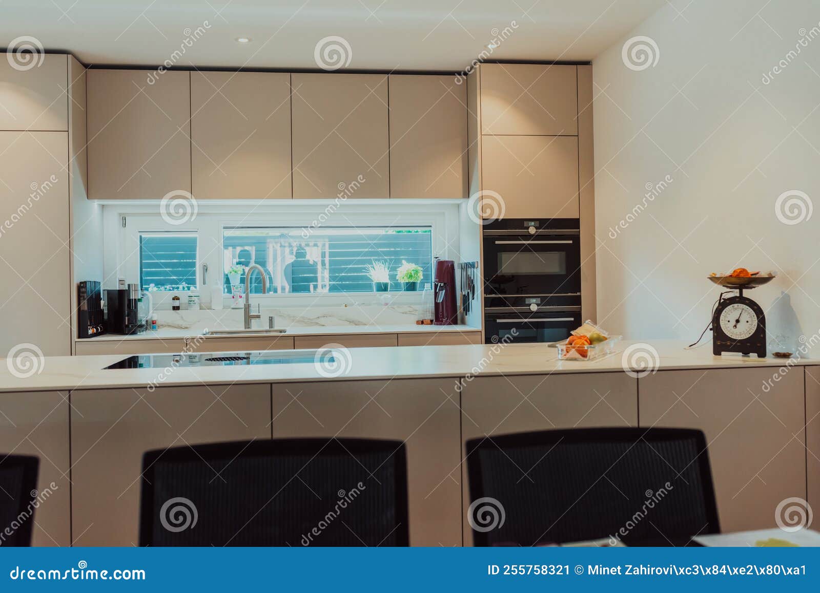 Modern White Kitchen with Electronic Devices and Decorative Items Stock ...