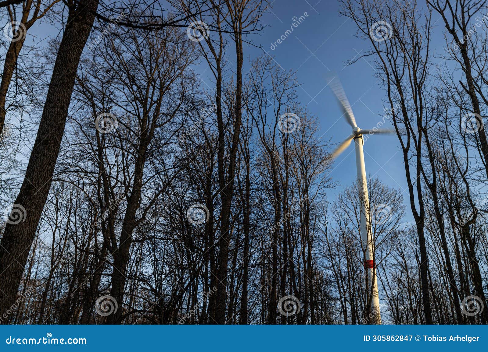 Modern Wind Turbine Spinning Behind Forest Trees Stock Image - Image of ...