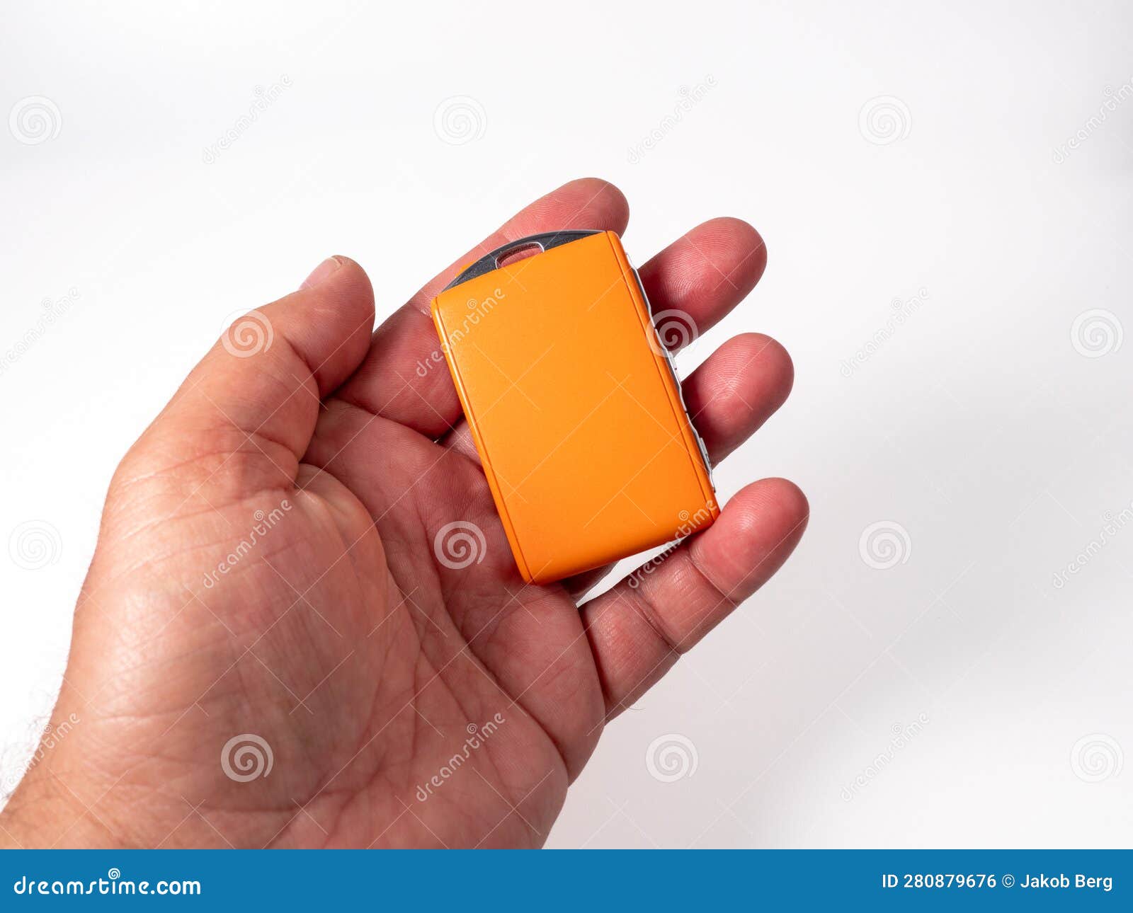 Modern Wireless Orange Ignition Key in Hand on a White Background ...