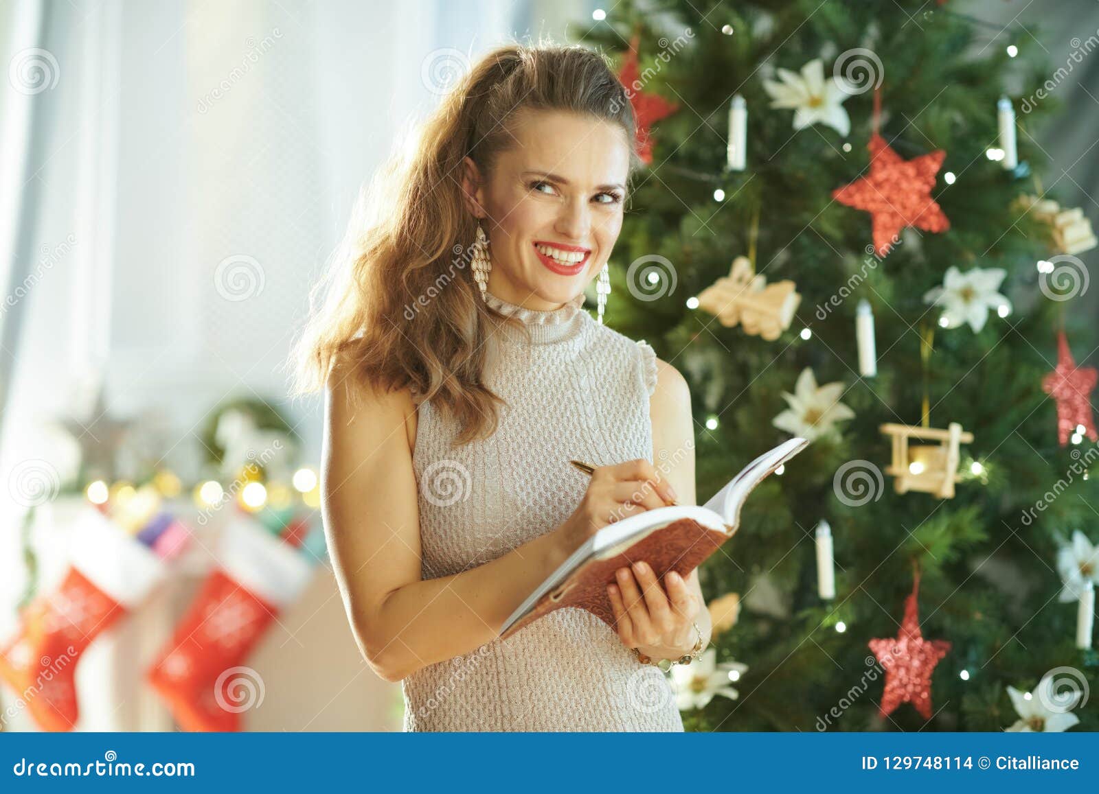 Modern Woman Near Christmas Tree Writing in Notebook Stock Photo ...