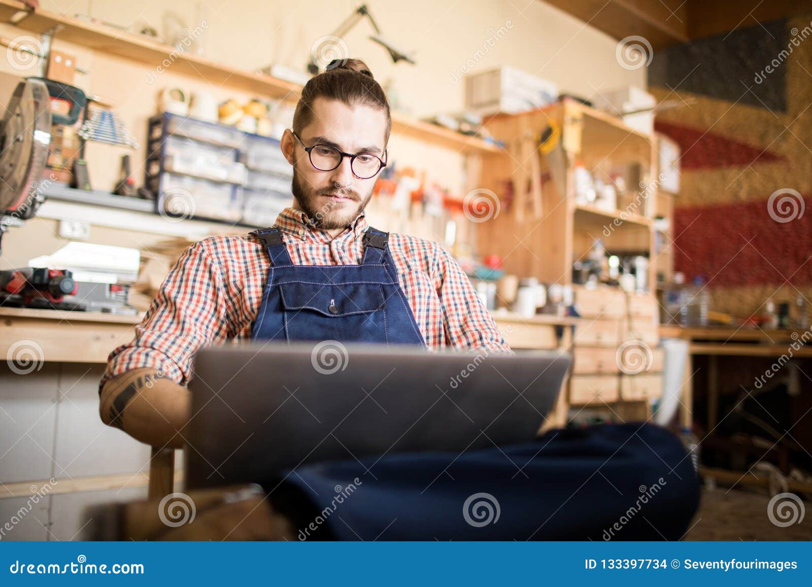 Modern Worker Using Laptop stock photo. Image of artisan - 133397734