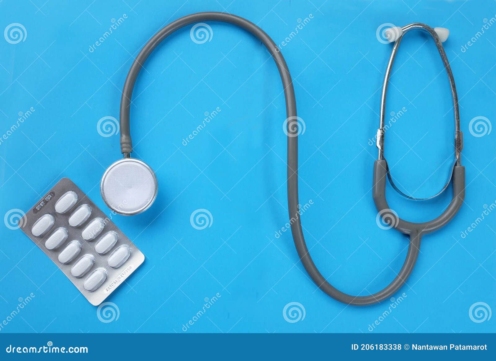Close Up Stethoscope And Pill Isolate On Blue Background Copy Space