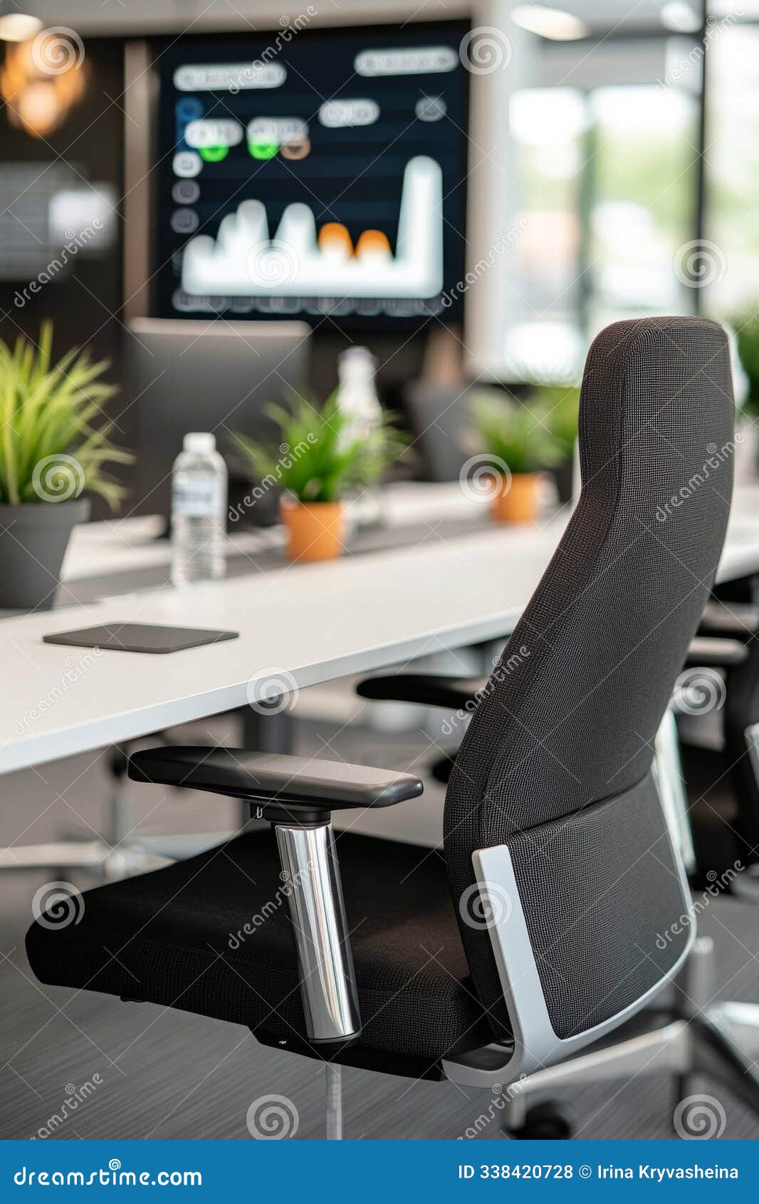Modern Workspace with an Ergonomic Chair, Plants, and Digital Display ...